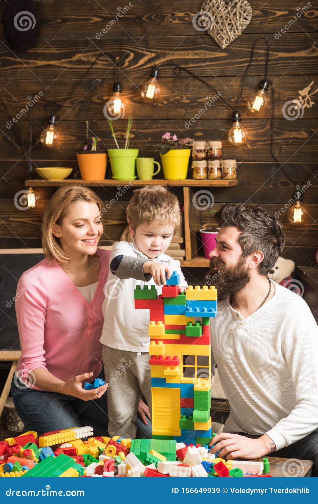 Kid with Parents Play with Plastic Blocks, Build Construction. Father ...
