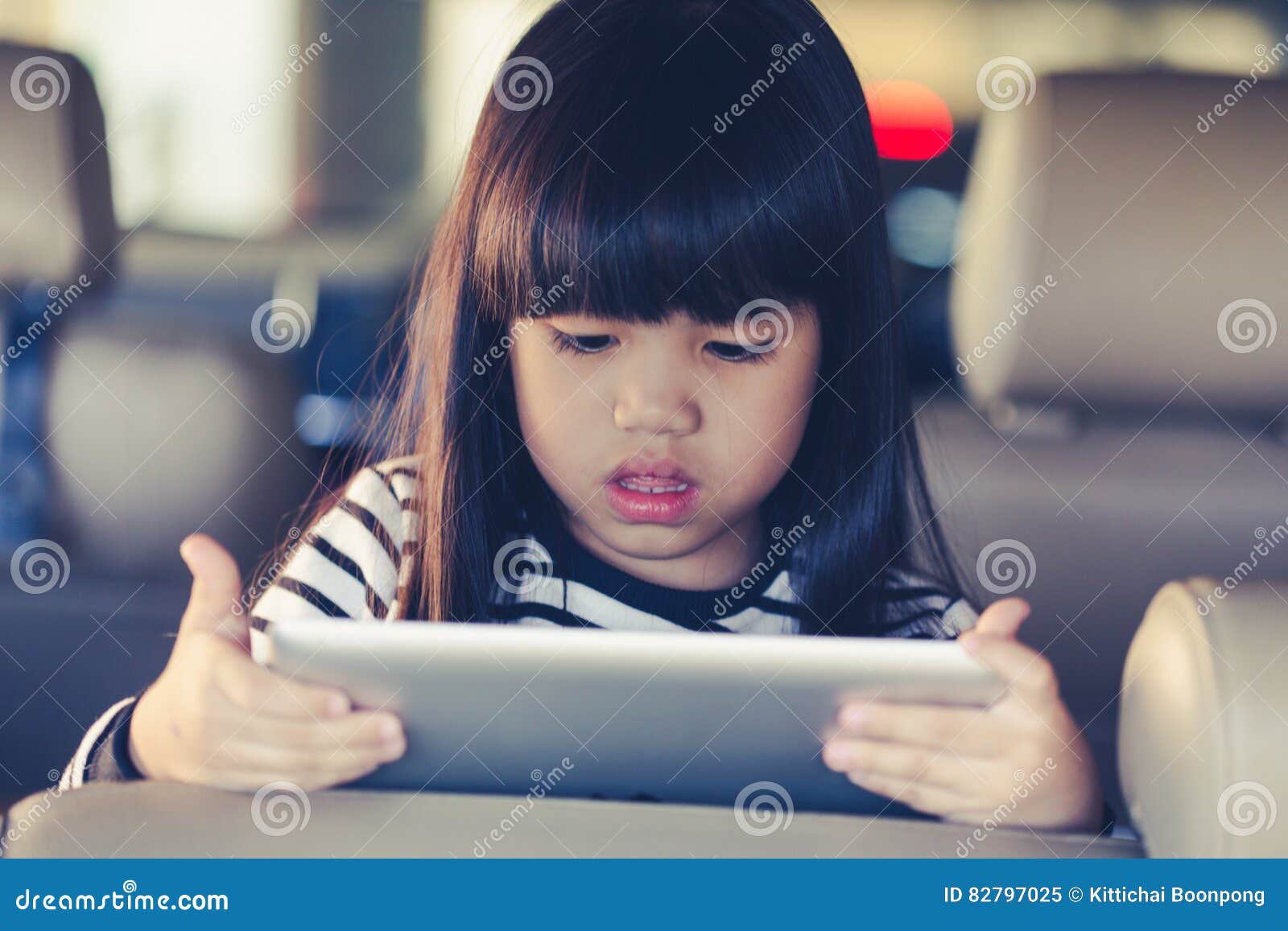 Kid play Tablet in car stock image. Image of home, boys - 82797025