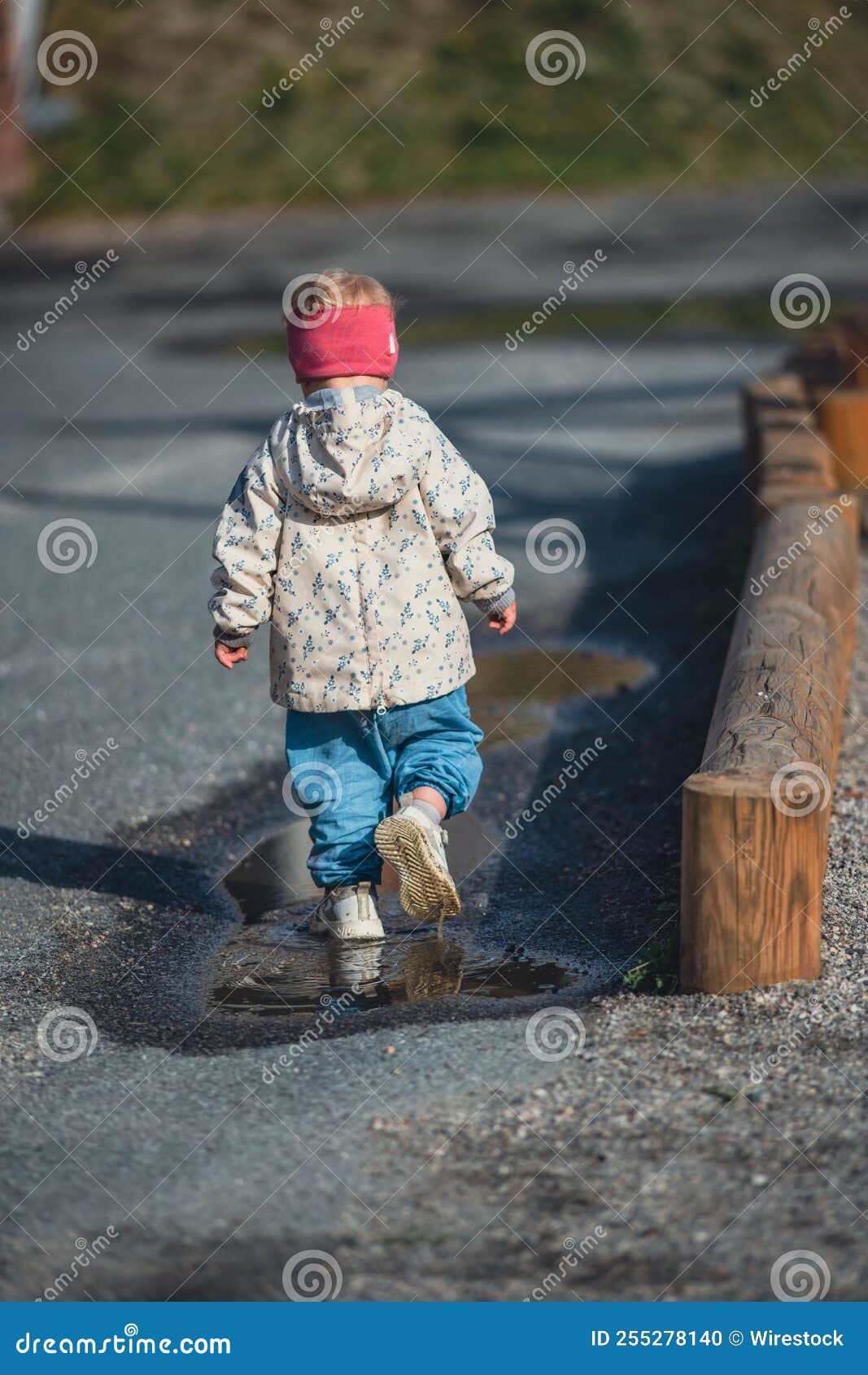 Kid Playfully Jumping into the Puddle Stock Photo - Image of asphalt ...