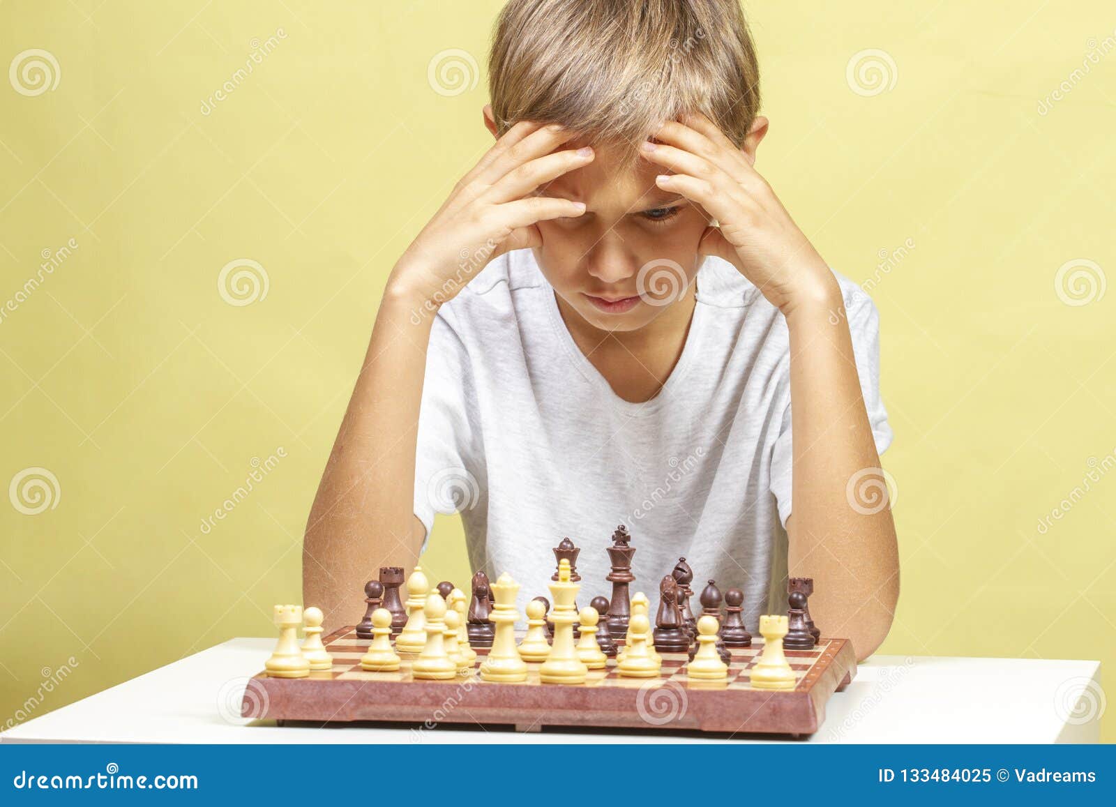 Kid Playing Chess. Boy Looking at Chess Board and Thinking about His ...