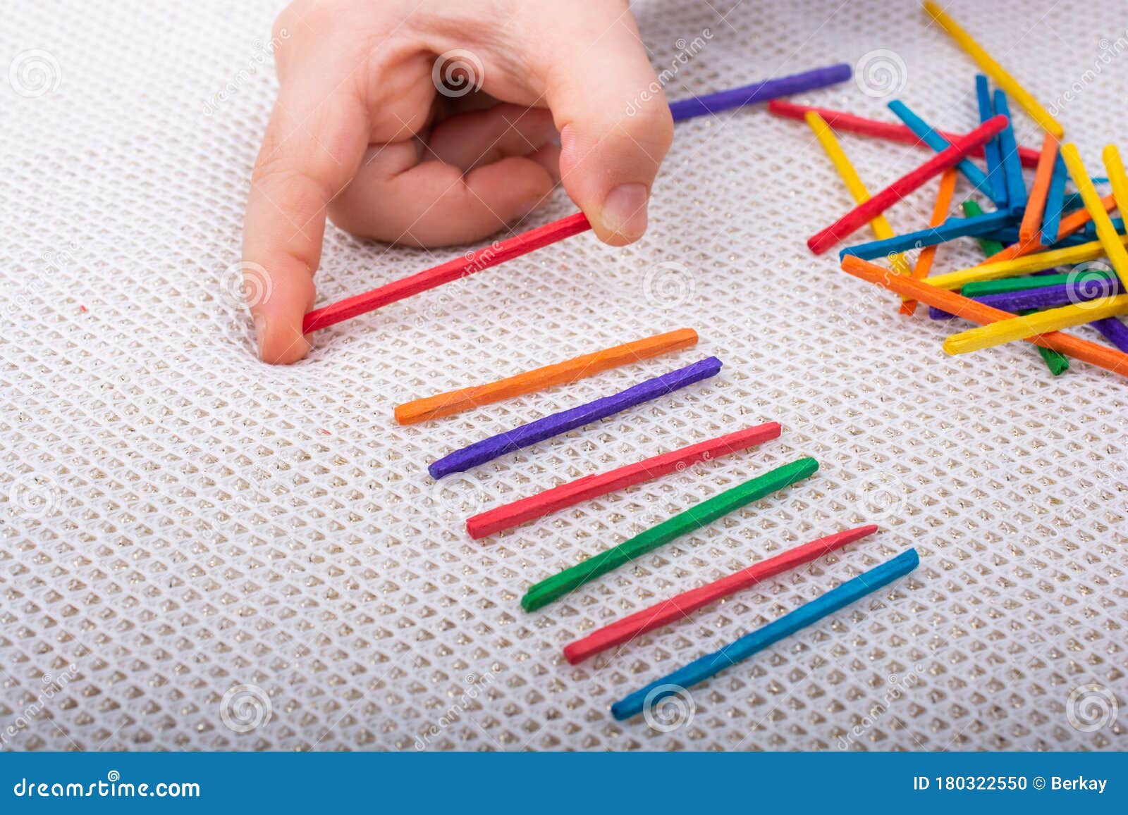 Kid Playing with Coloured Wooden Sticks for Creativity Stock Photo ...