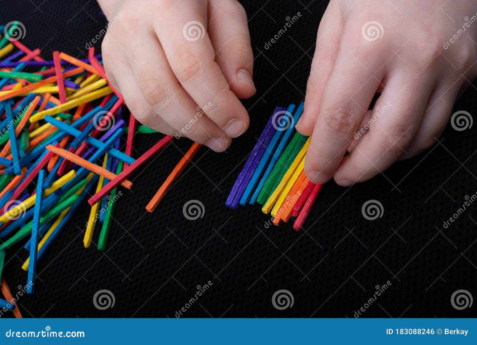Kid Playing with Coloured Wooden Sticks for Creativity Stock Photo ...