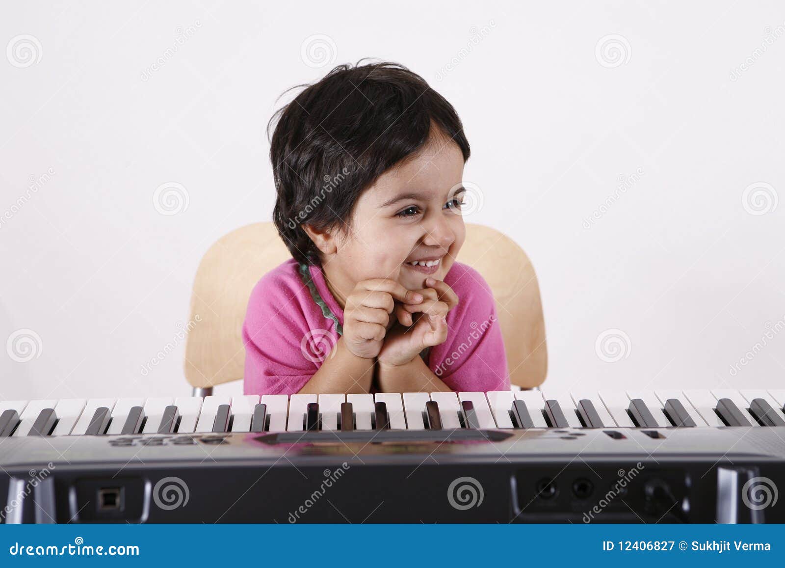 Kid playing a keyboard stock image. Image of artistic - 12406827