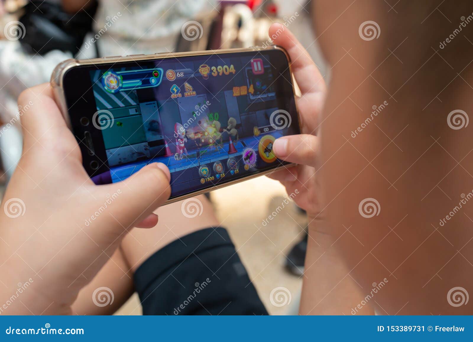 Kid playing a mobile game editorial photo. Image of game - 153389731