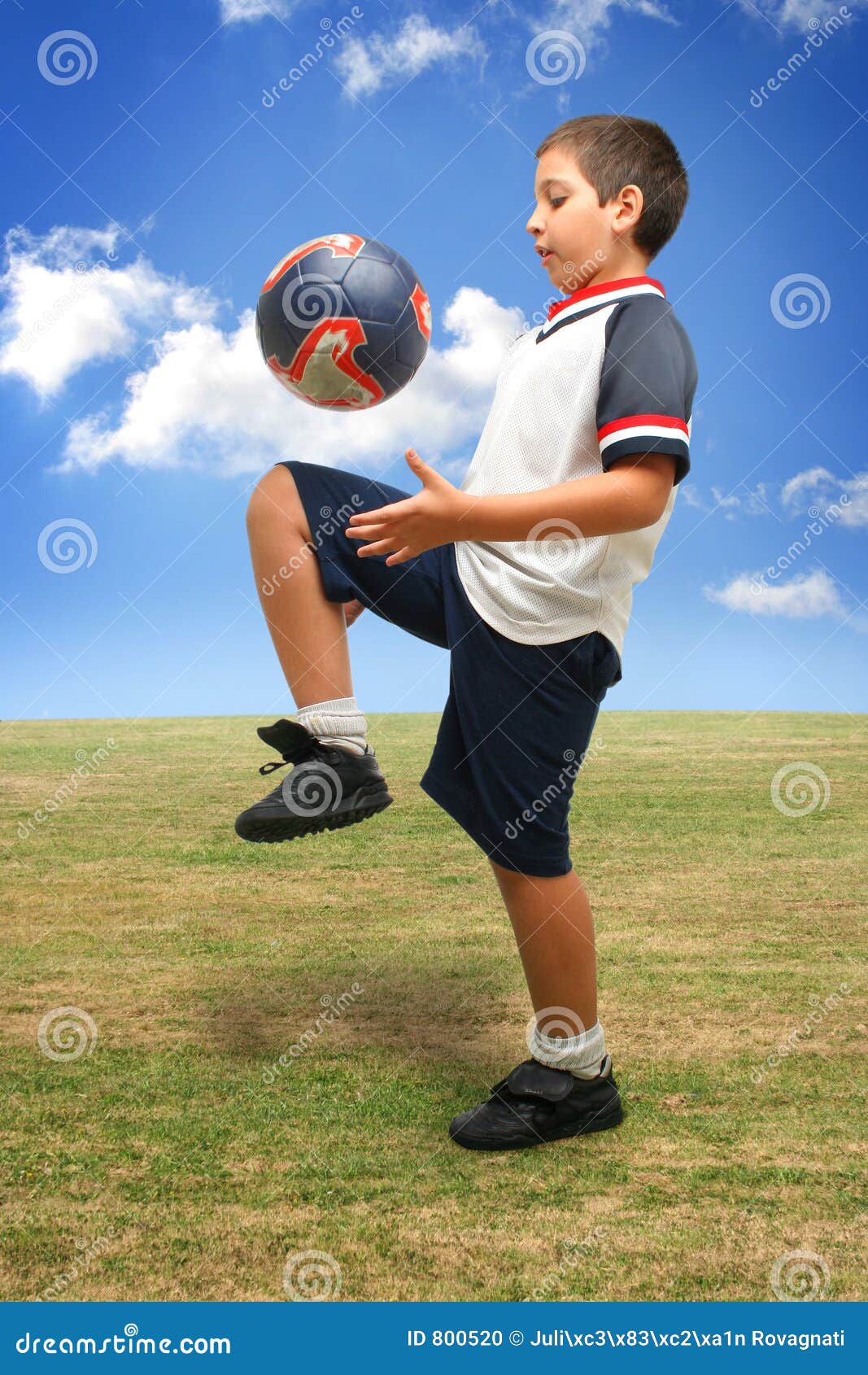 Kid playing soccer outside stock photo. Image of boots - 800520