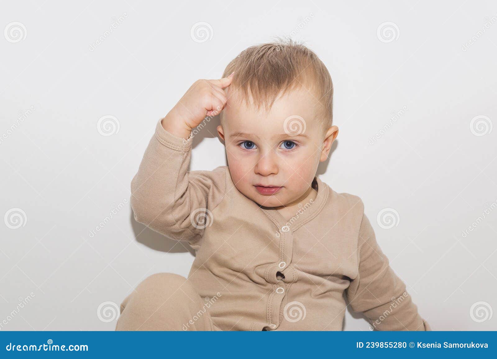 Kid Points a Finger at His Head Stock Photo - Image of looking, clever ...