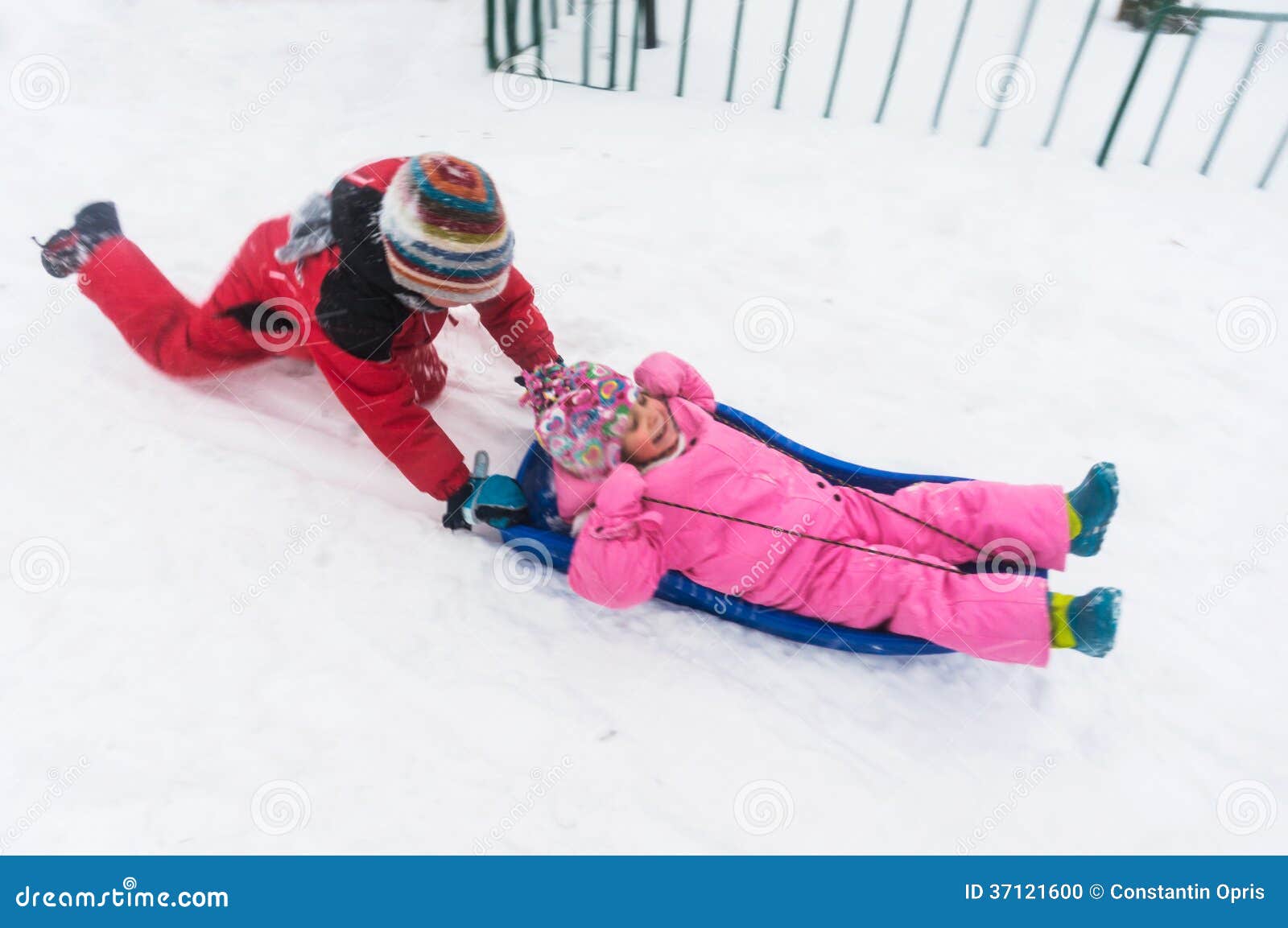 Kid pushing bob sledge stock photo. Image of ride, cold - 37121600