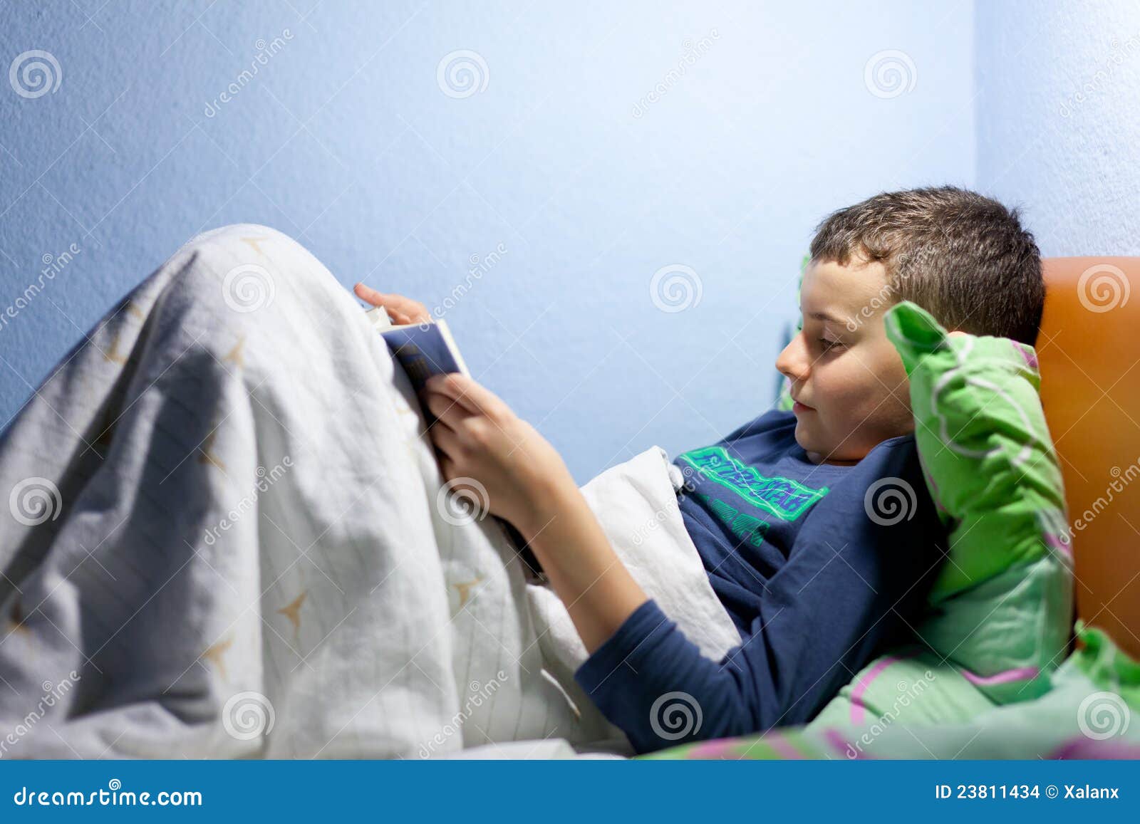 Kid Reading a Book at Bedtime Stock Photo - Image of pajamas, book ...