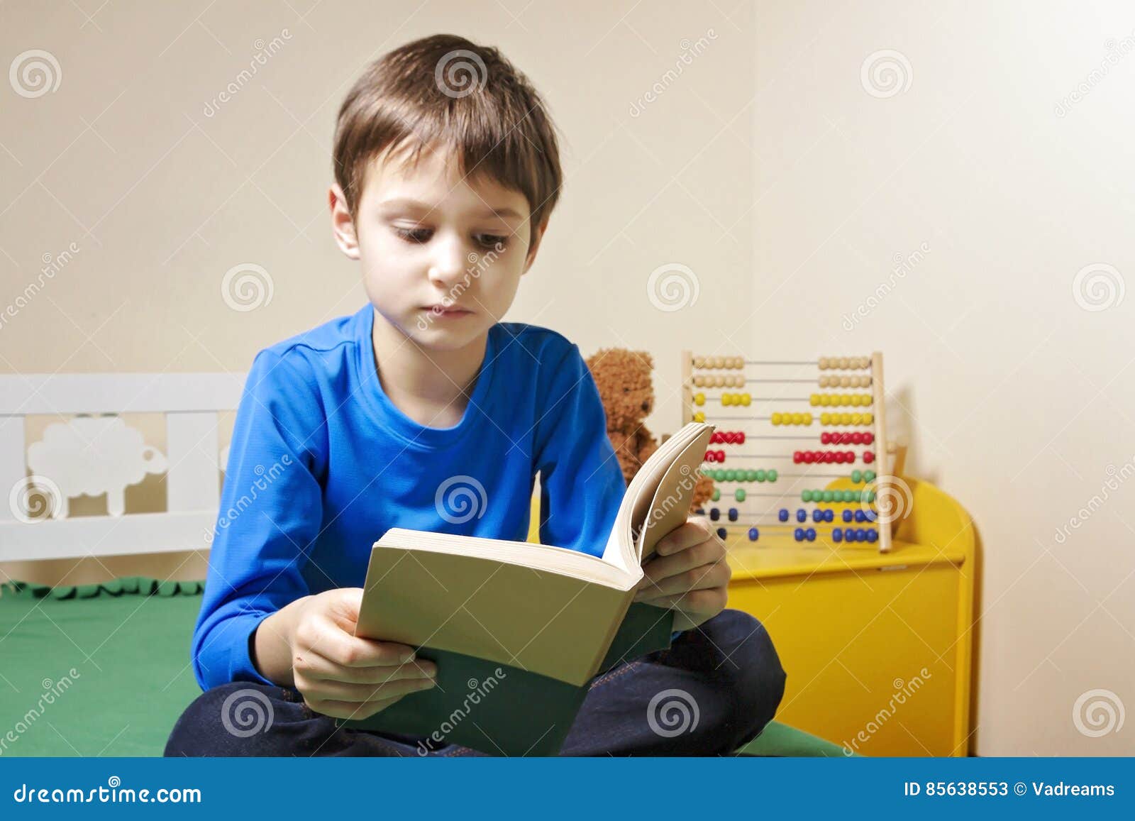 Kid reading a book at home stock image. Image of education - 85638553