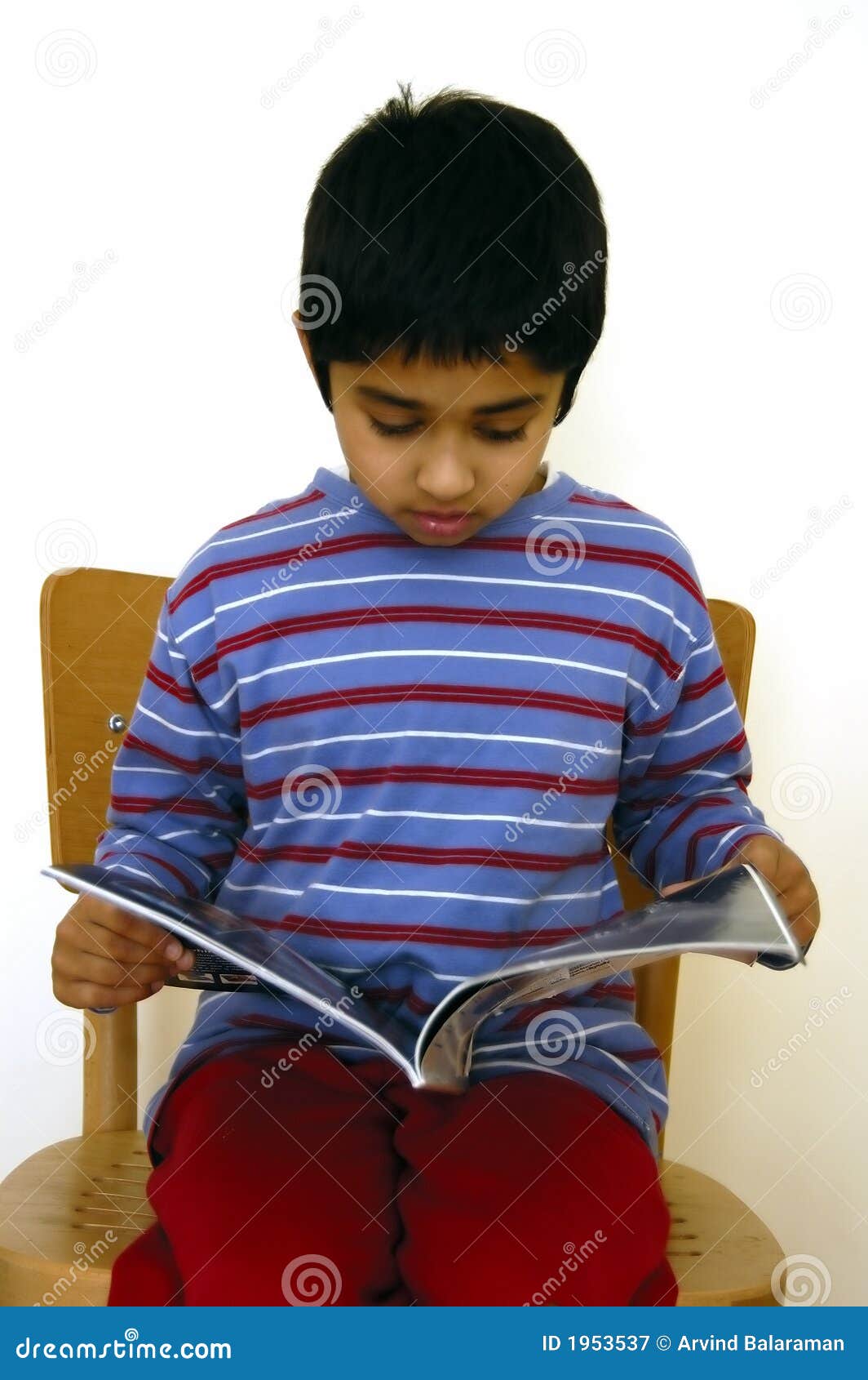 Kid reading a magazine stock image. Image of livingroom - 1953537