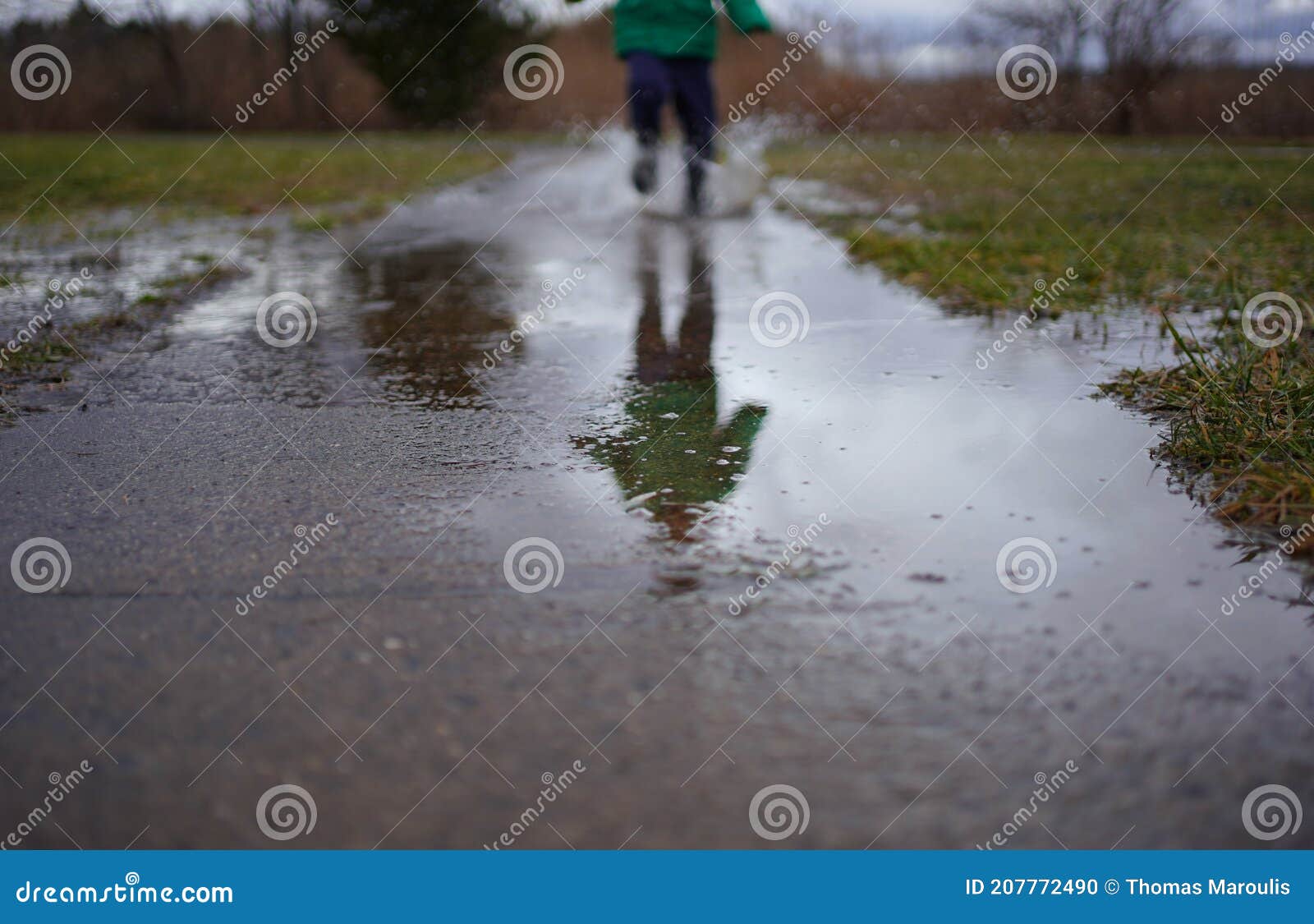 Kid reflection on sidewalk stock photo. Image of puddle - 207772490