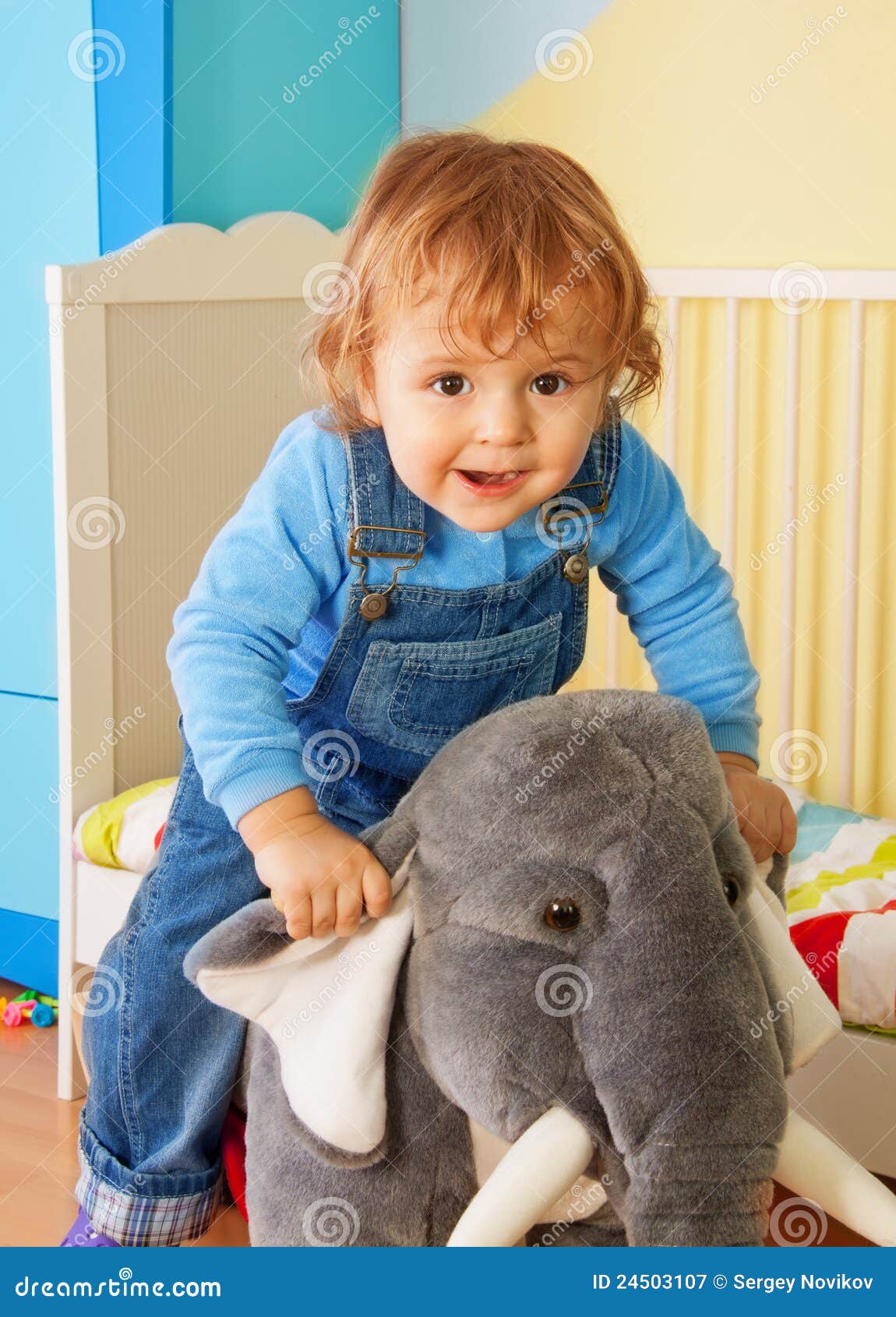 Kid riding a toy elephant stock image. Image of denim - 24503107
