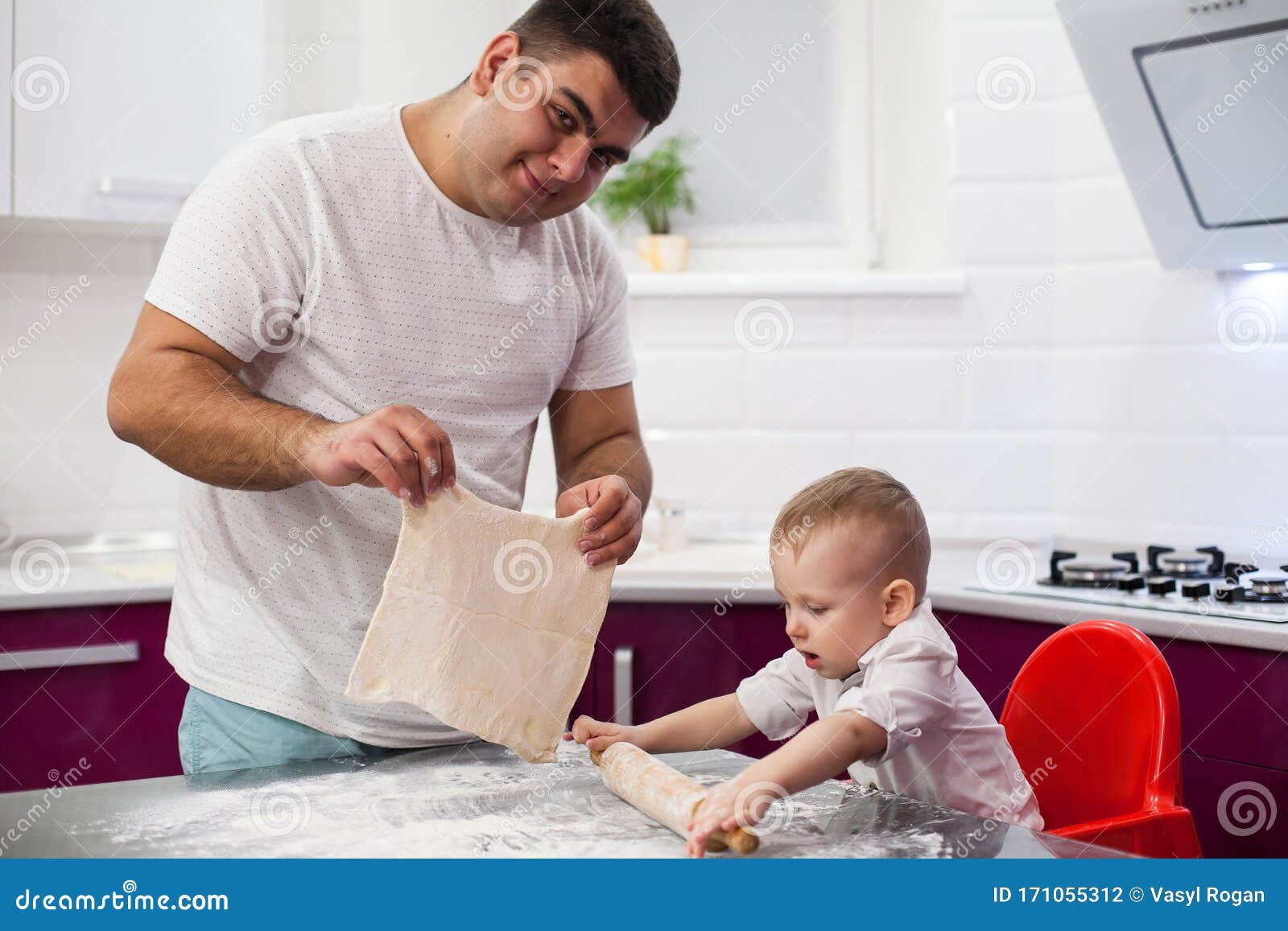 Kid Rolls Out the Pizza Dough. Happy Family in Kitchen Stock Photo ... Kid Rolls Out the Pizza Dough. Happy Family in Kitchen Stock Photo ...
