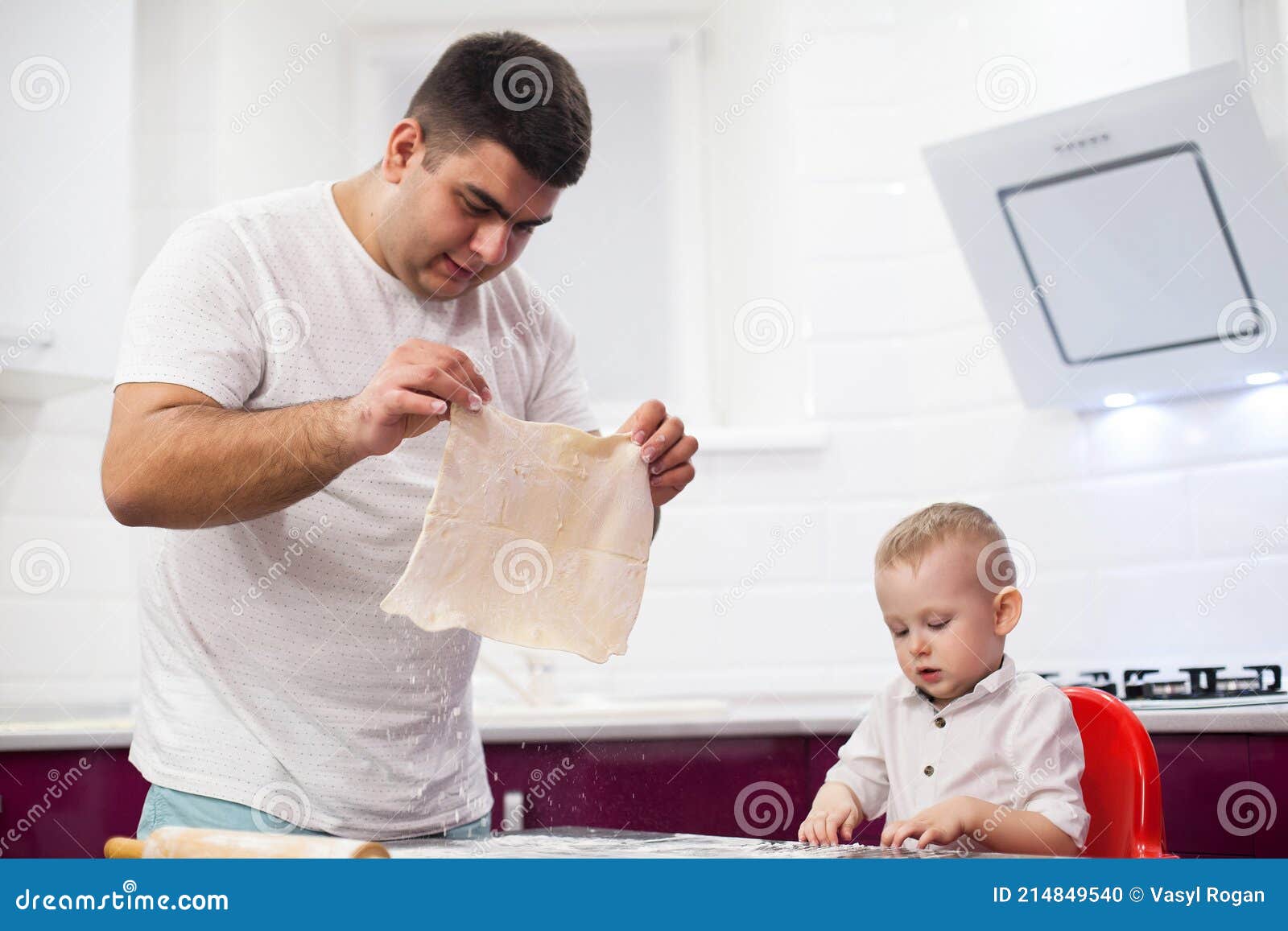 Kid Rolls Out the Pizza Dough. Happy Family in Kitchen Stock Photo ... Kid Rolls Out the Pizza Dough. Happy Family in Kitchen Stock Photo ...