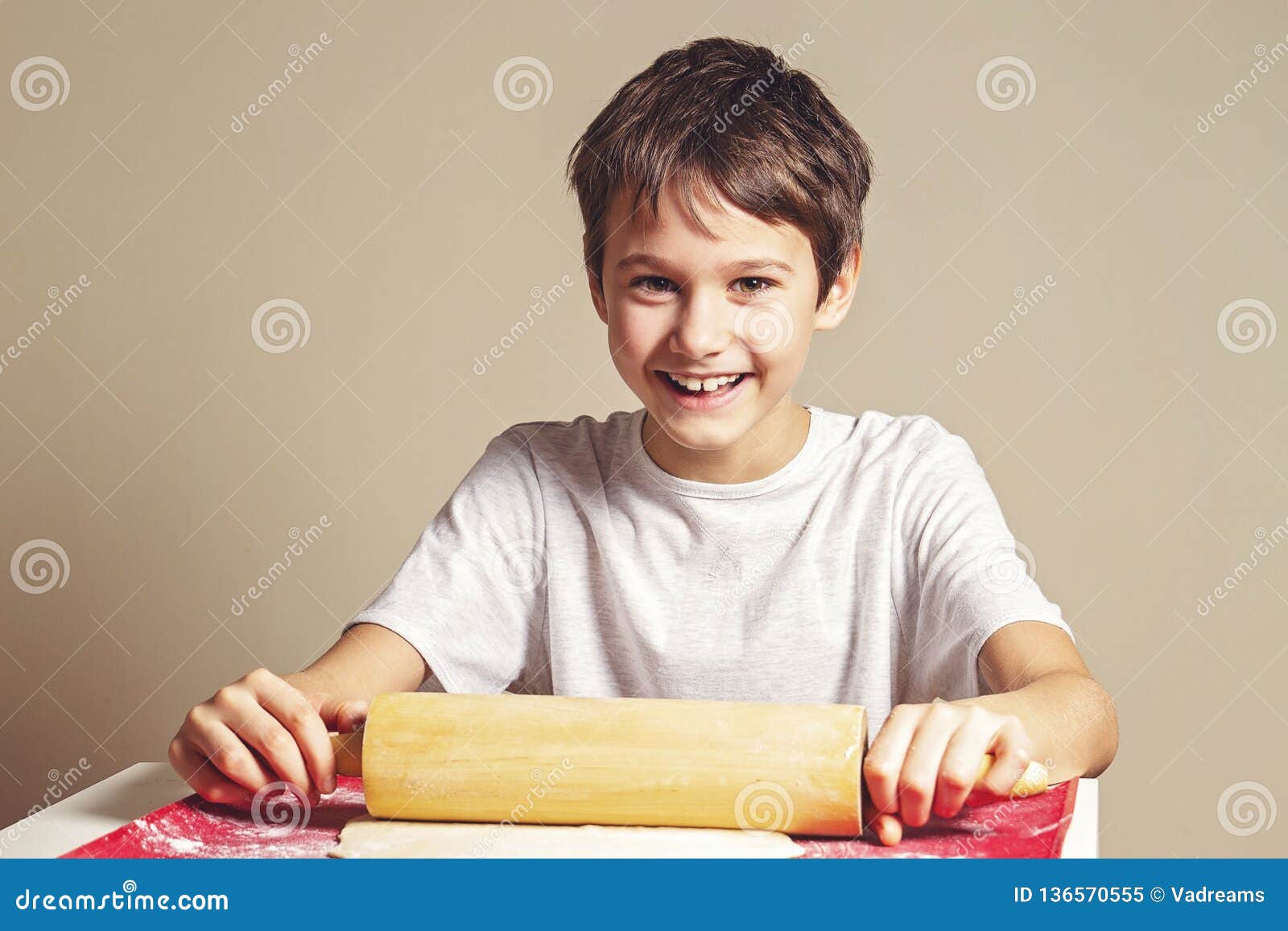 Kid Rolls Out the Pizza Dough with the Rolling Pin on Silicone Dough ... Kid Rolls Out the Pizza Dough with the Rolling Pin on Silicone Dough ...