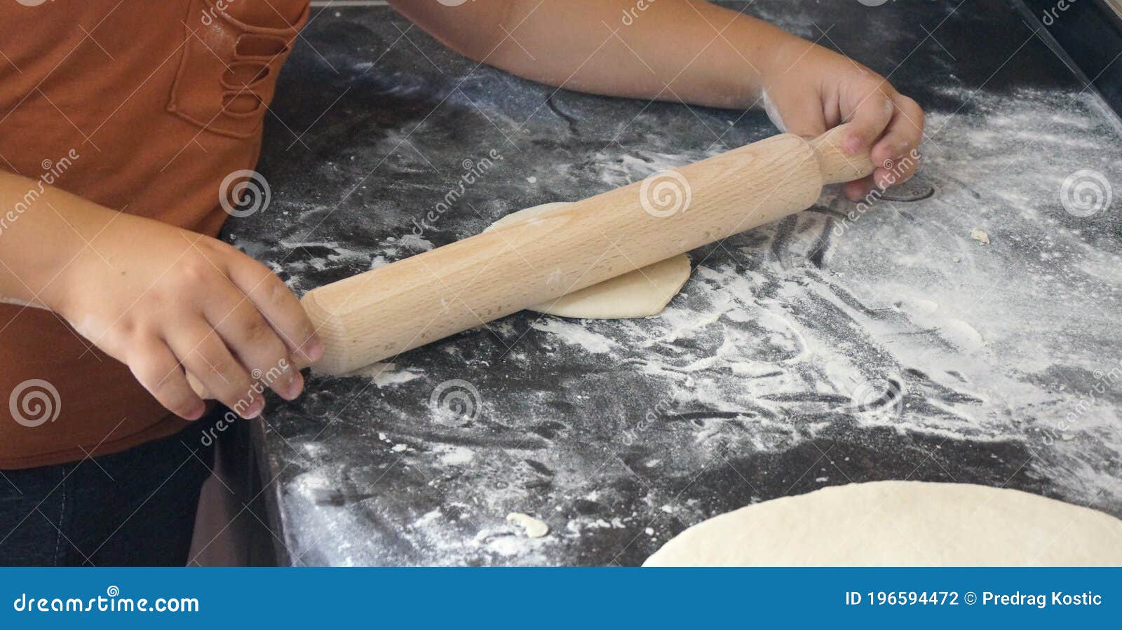 Kid Rolls Out the Pizza Dough with the Rolling Pin on Silicone Dough ... Kid Rolls Out the Pizza Dough with the Rolling Pin on Silicone Dough ...