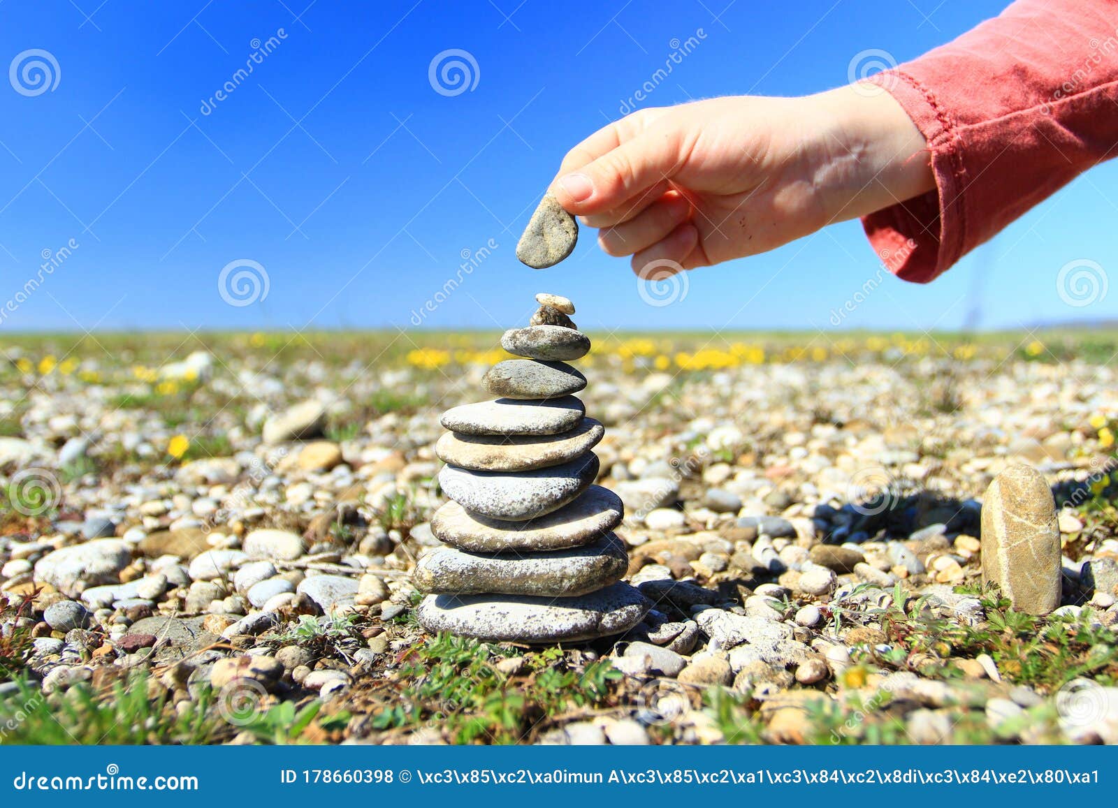 Kid`s Hand Fixing Rock on the Top of Stone Stack Stock Photo - Image of ...