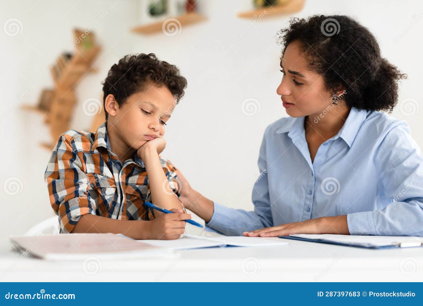 Mom Comforting Unhappy Schoolboy Son Having Issue with Homework Indoors ...