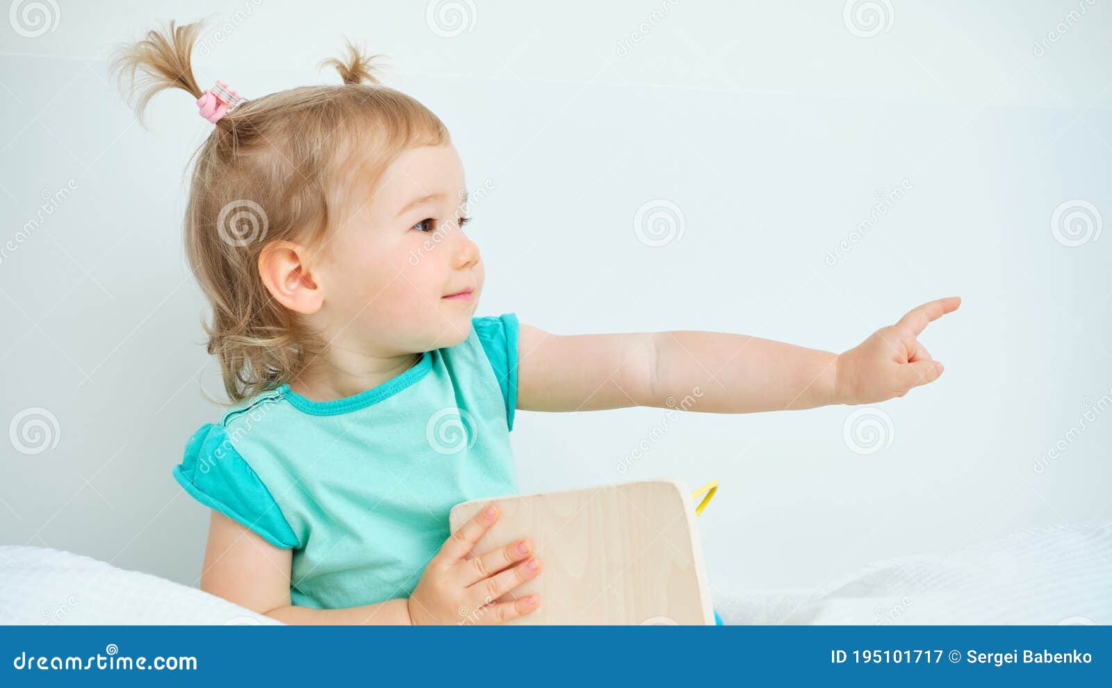 Kid Shows a Finger To the Side on a White Background Stock Image ...