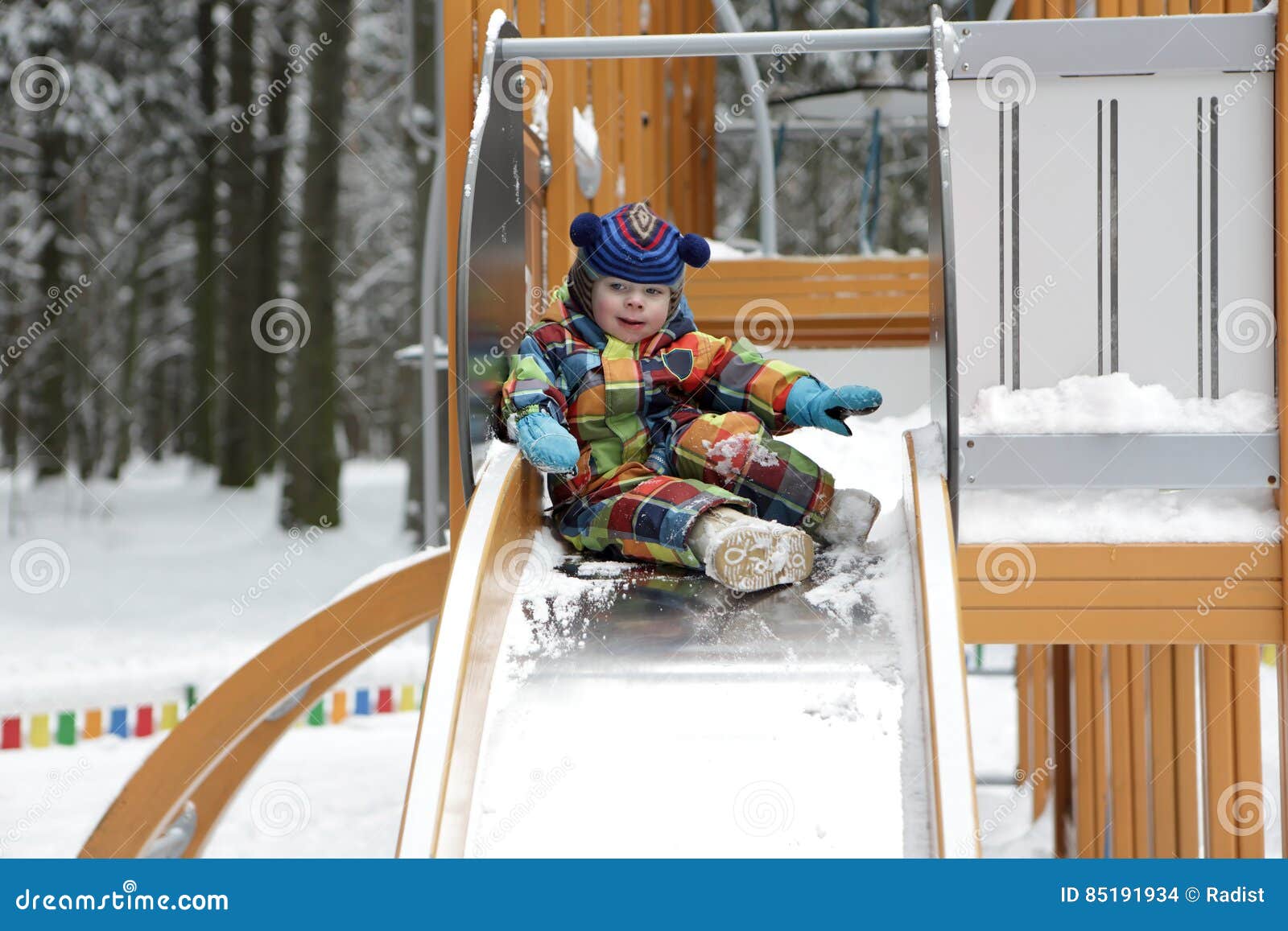 Kid sitting on slide stock photo. Image of park, freeze - 85191934