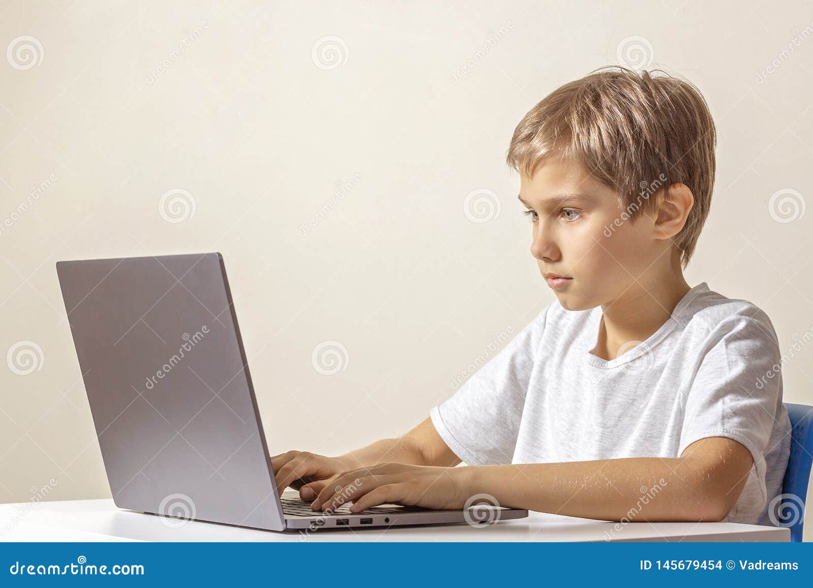 Boy Sitting at the Table and Using Laptop Computer Stock Photo - Image ...