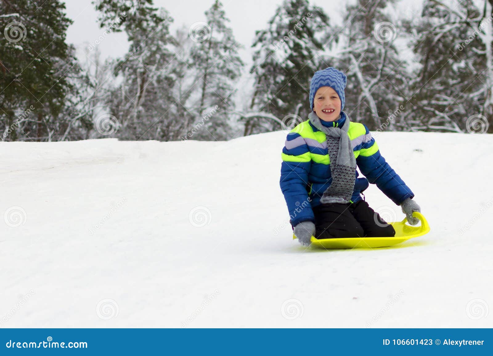Kid Slides Down a Hill on Plate for Driving on Snow Stock Image - Image ...