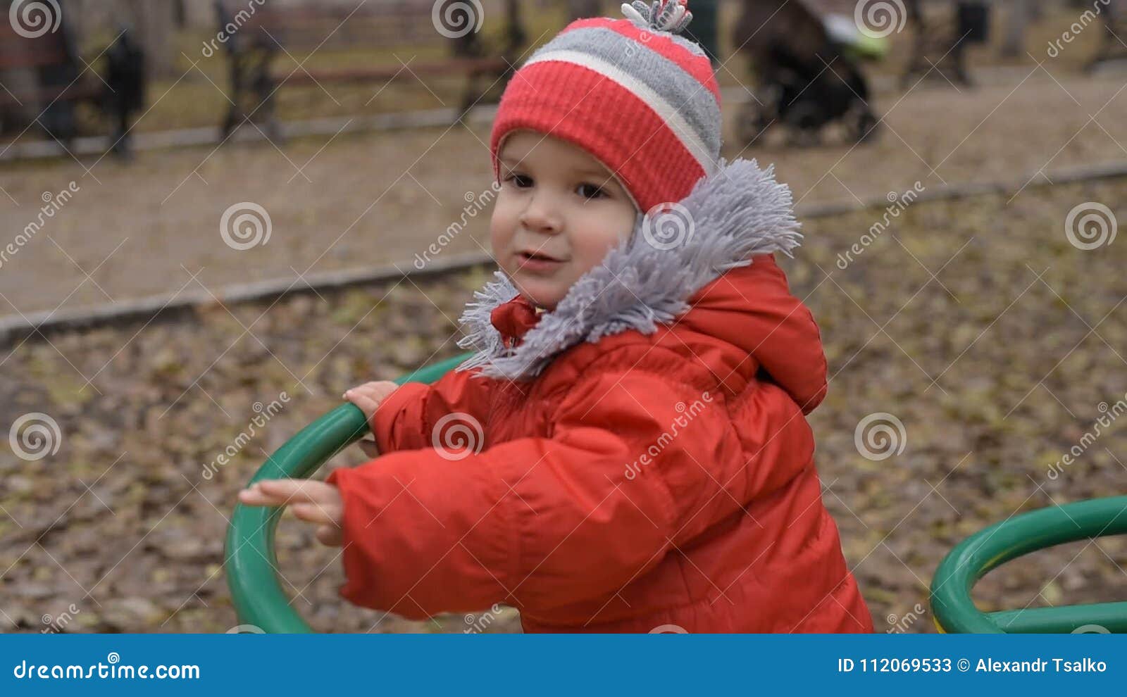 The Child is Spinning on a Swing in the Playground in the Park Stock ...