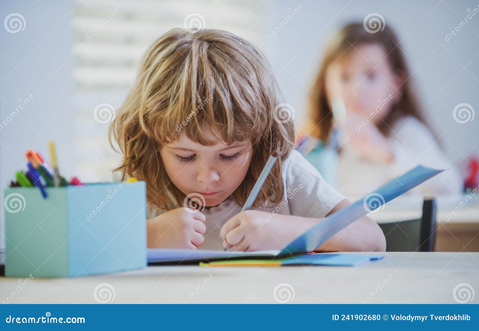 Kid Studying at School. Schoolchild Doing Homework at Classroom ...