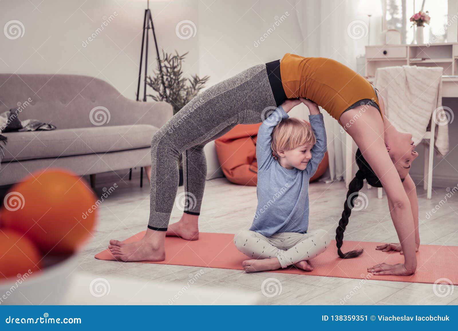 Kid Supporting His Mother Doing a Backbend Stock Image - Image of ...