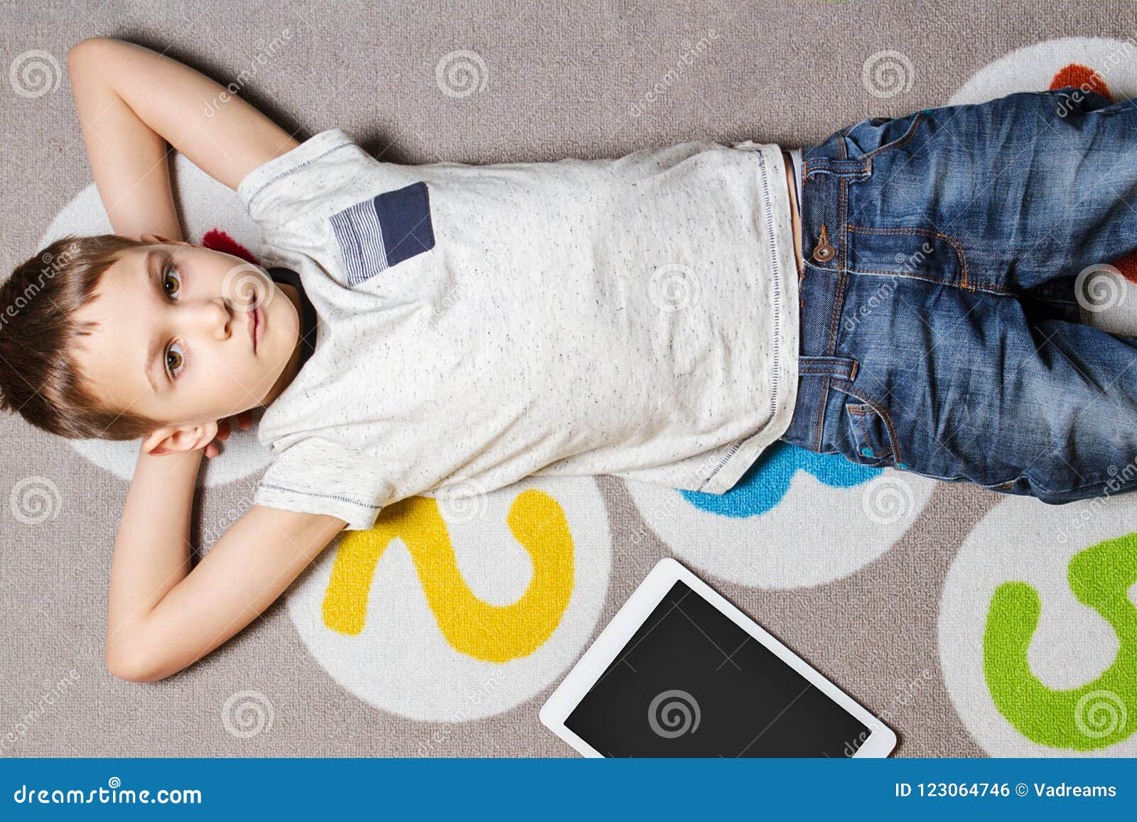 Kid with Tablet Computer Lying on the Floor at Home Stock Photo - Image ...