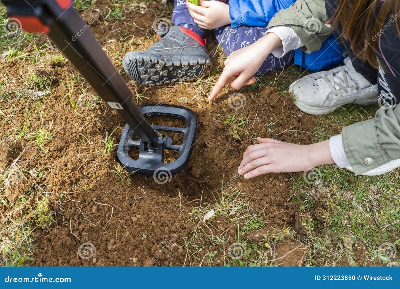 Kid Treasure Hunters Metal Detecting and Digging the Ground Stock Photo ...