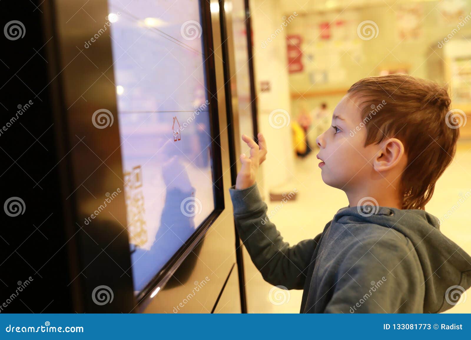 Kid using touch screen stock image. Image of device - 133081773