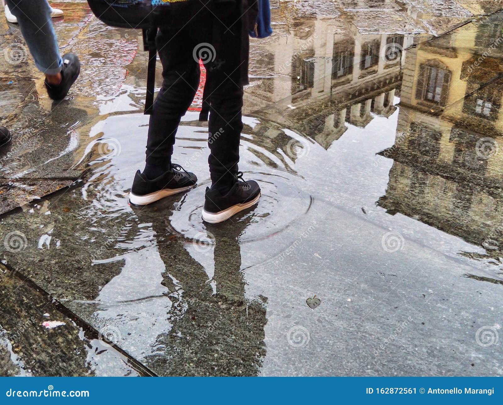 Kid Walking in the Puddle of Water after the Rainstorm Stock Image ...