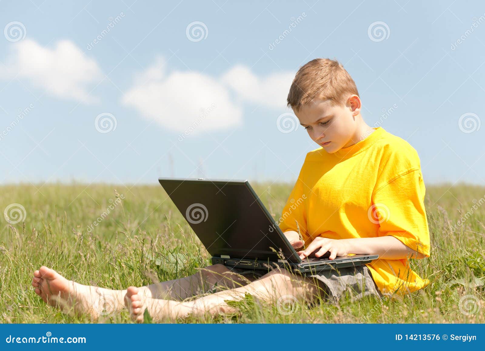 Kid is Working on the Laptop Sitting on the Meadow Stock Photo - Image ...
