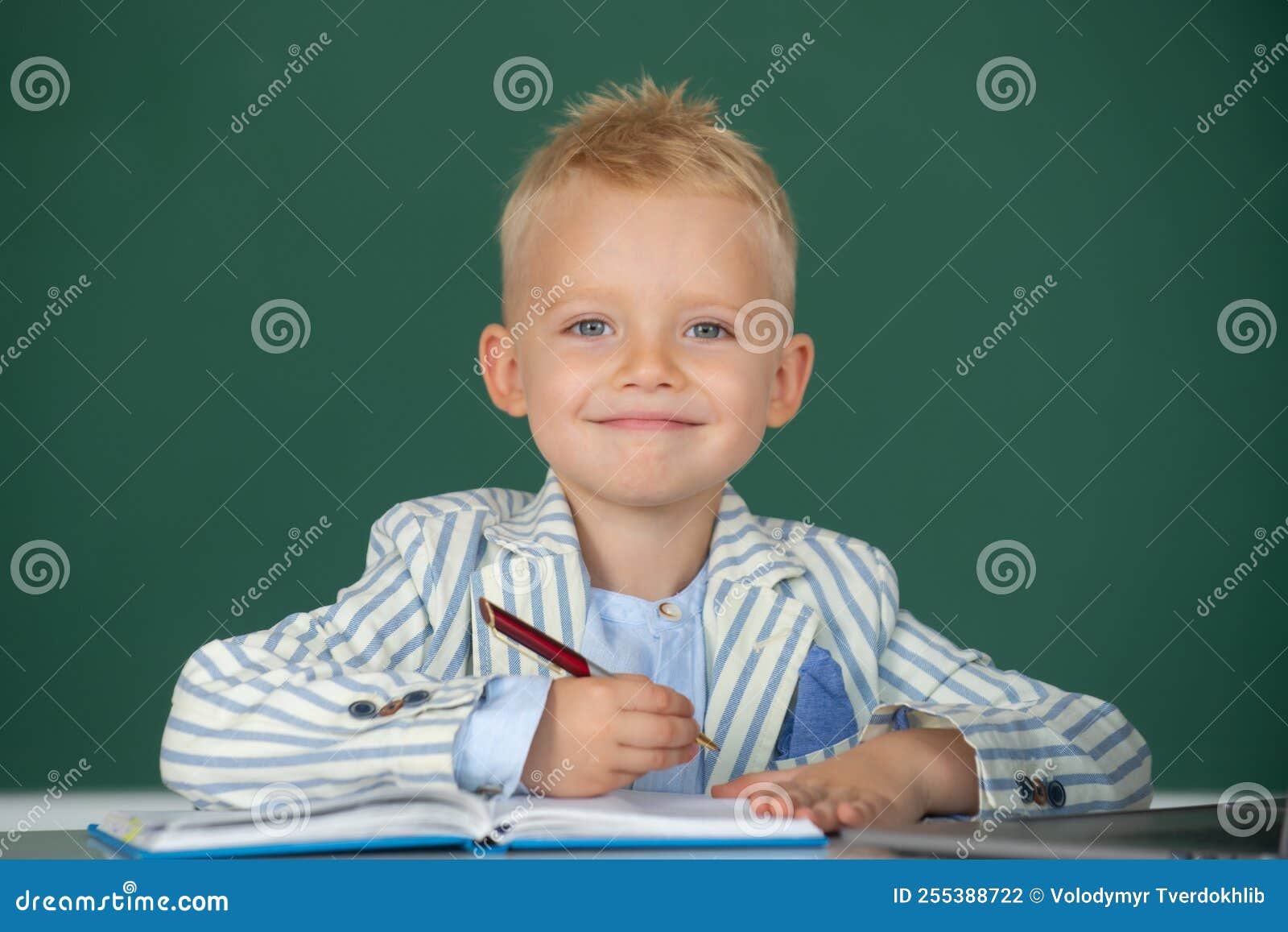 Kid Writing in Class. Child at School. Kid is Learning in Class on ...