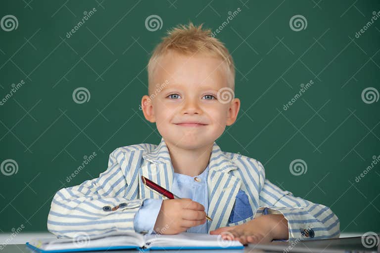 Kid Writing in Class. Child at School. Kid is Learning in Class on ...