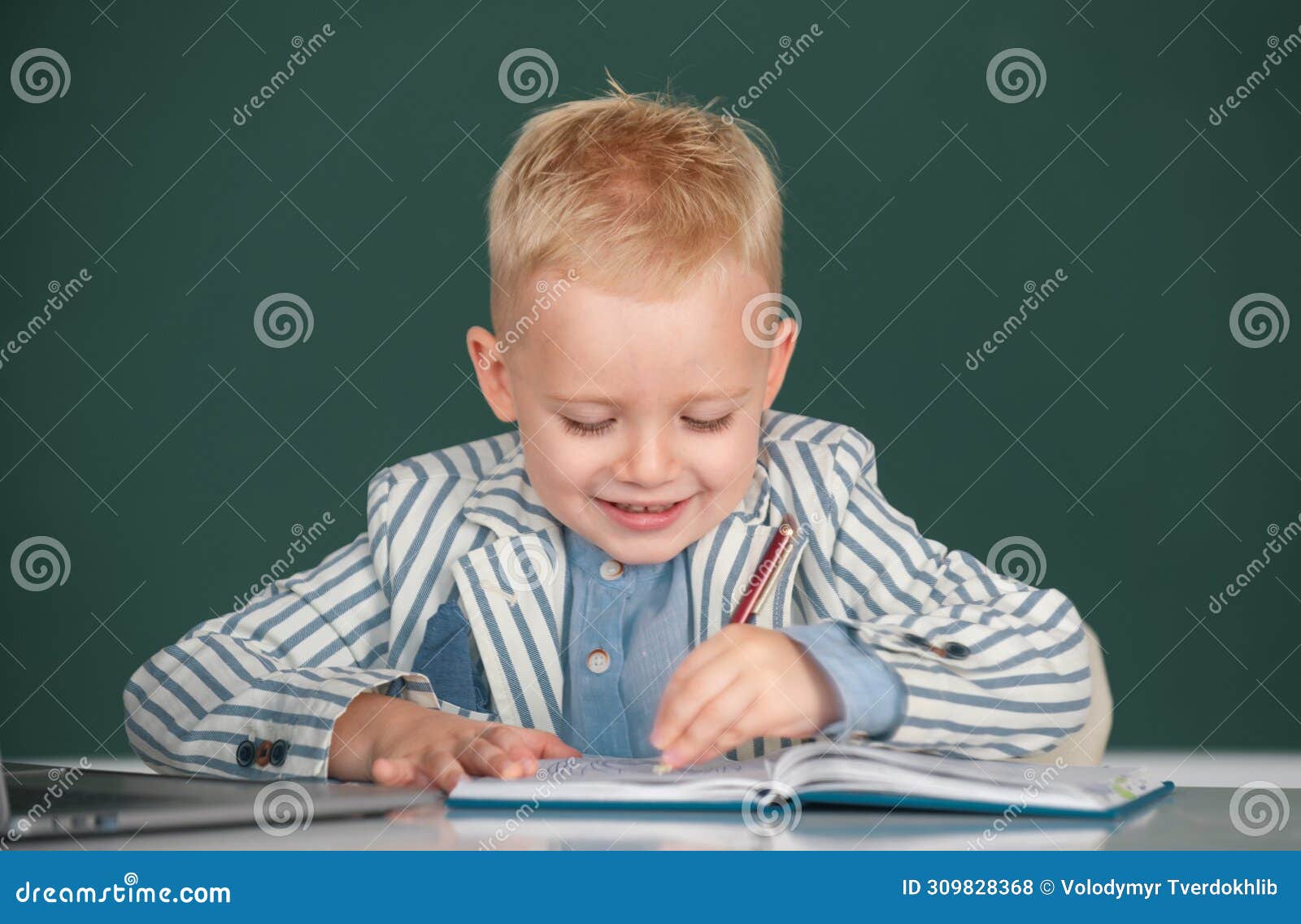 Kid Writing in Class. Portrait of Funny Pupil of Primary School Study ...