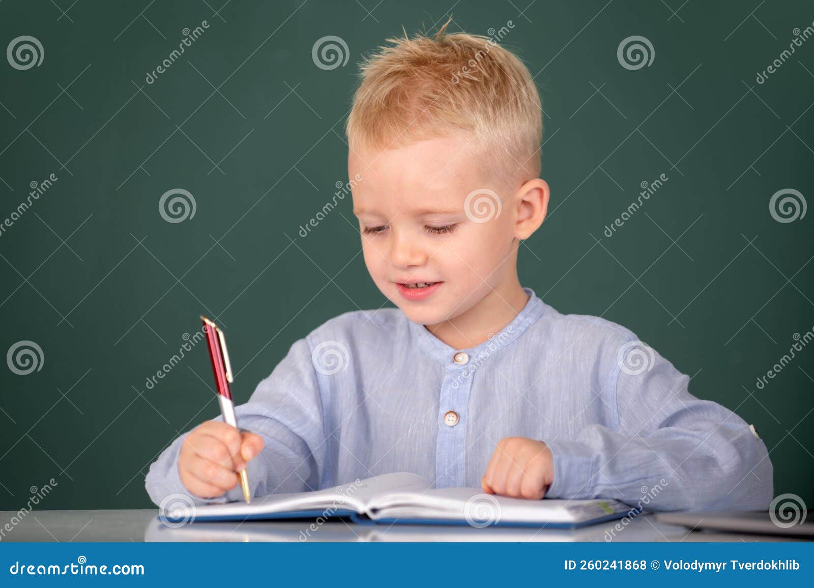 Kid Writing in Class. School Boy Studying Math on Lesson in Classroom ...