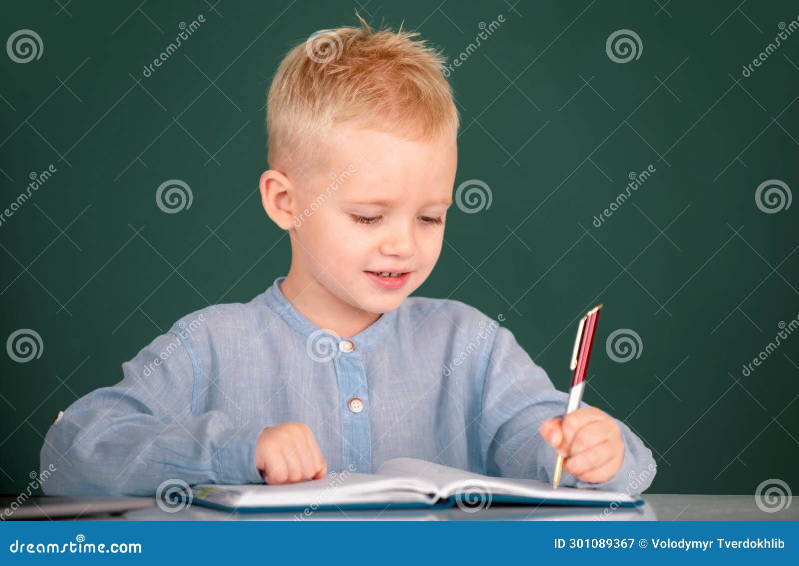 Kid Writing in Class. School Boy Studying Math on Lesson in Classroom ...