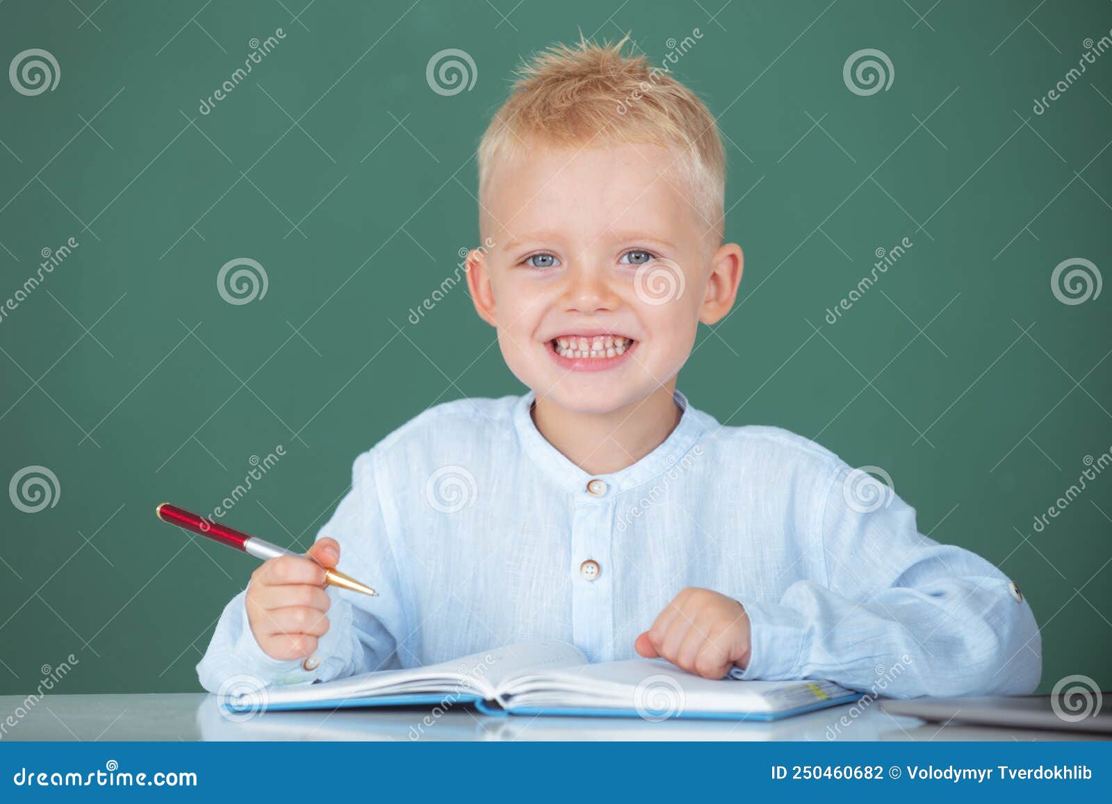 Kid Writing in Notebook in Class. Little Student Child Studying in ...