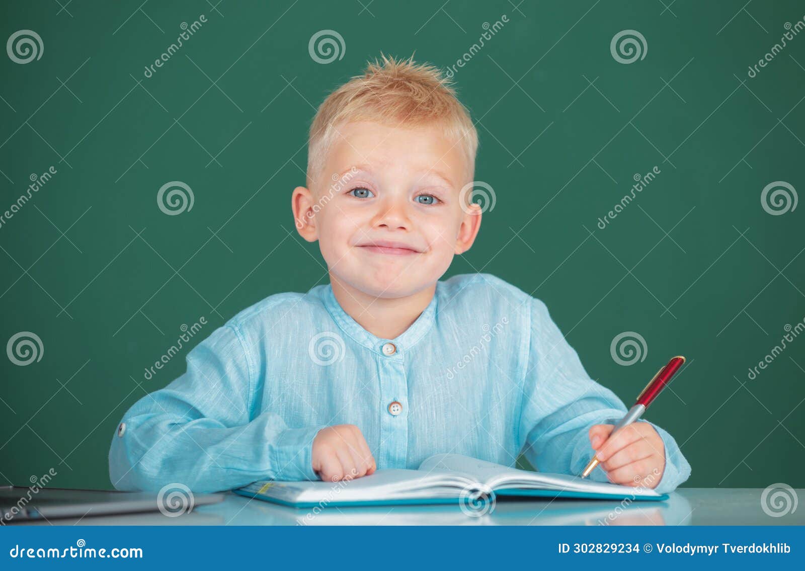 Kid Writing in Notebook in Class. Portrait of Funny Pupil of Primary ...