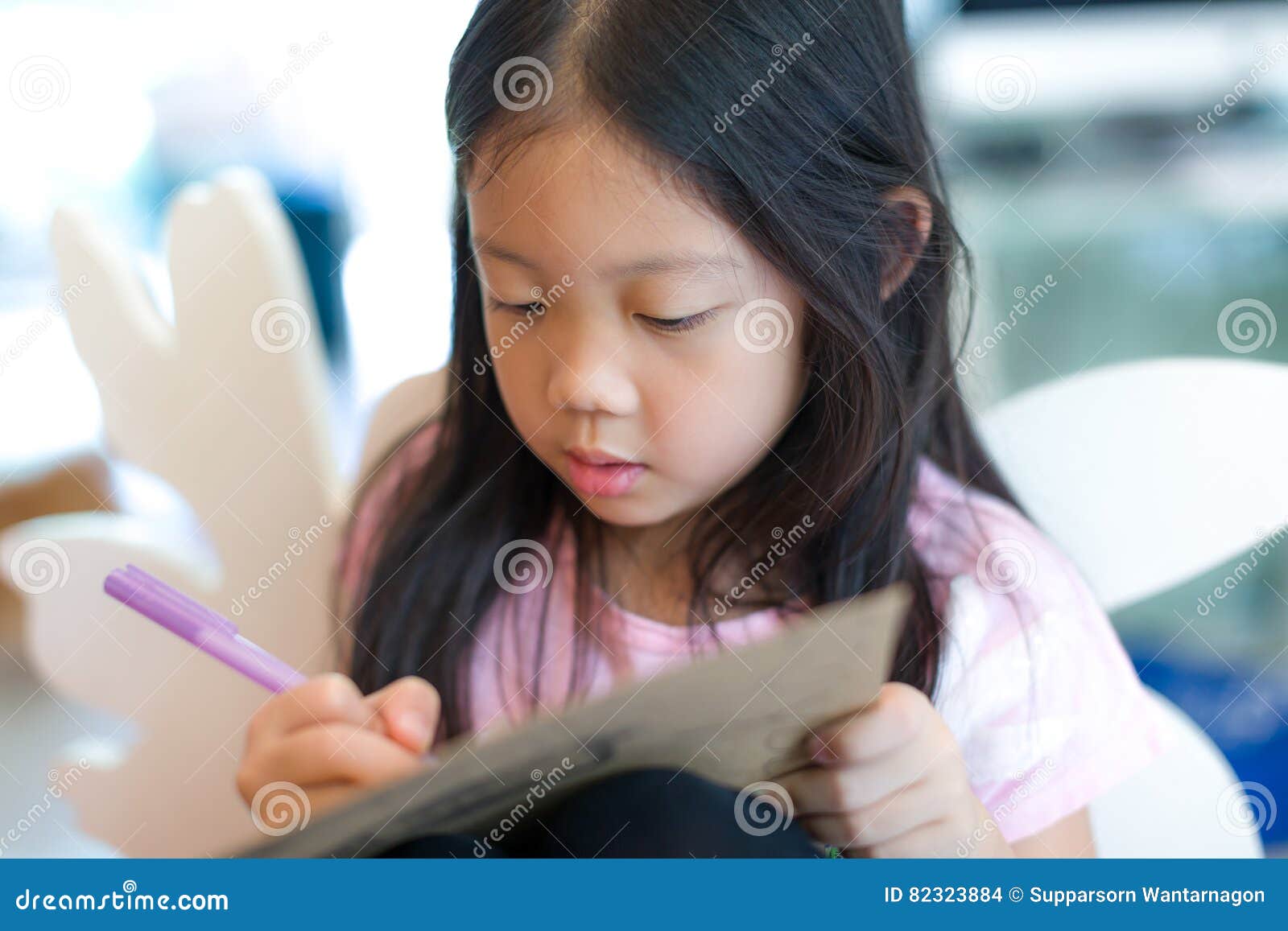 Kid Writing on Notebook stock photo. Image of plastic - 82323884