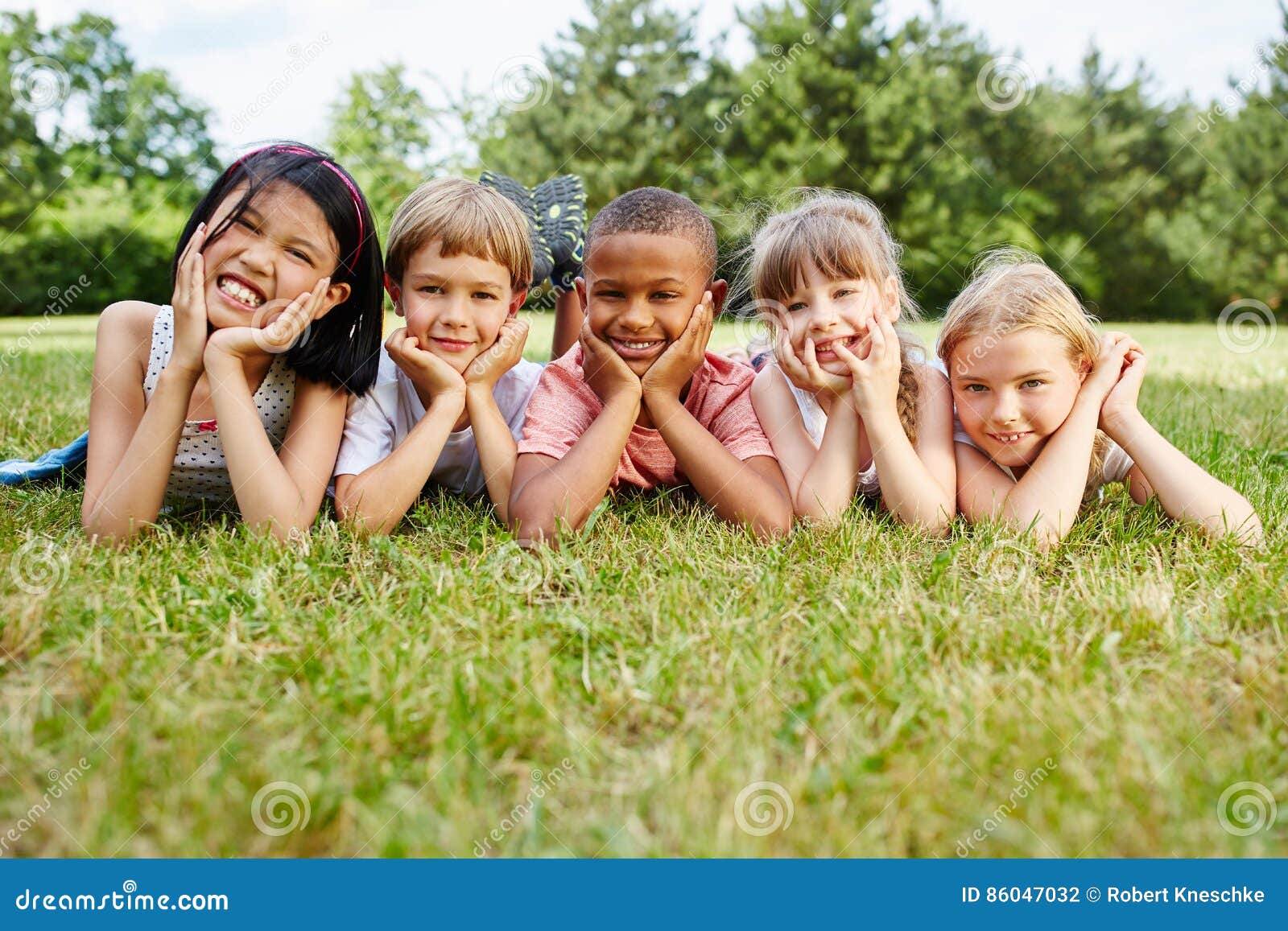 Kids as friends at meadow stock photo. Image of international - 86047032