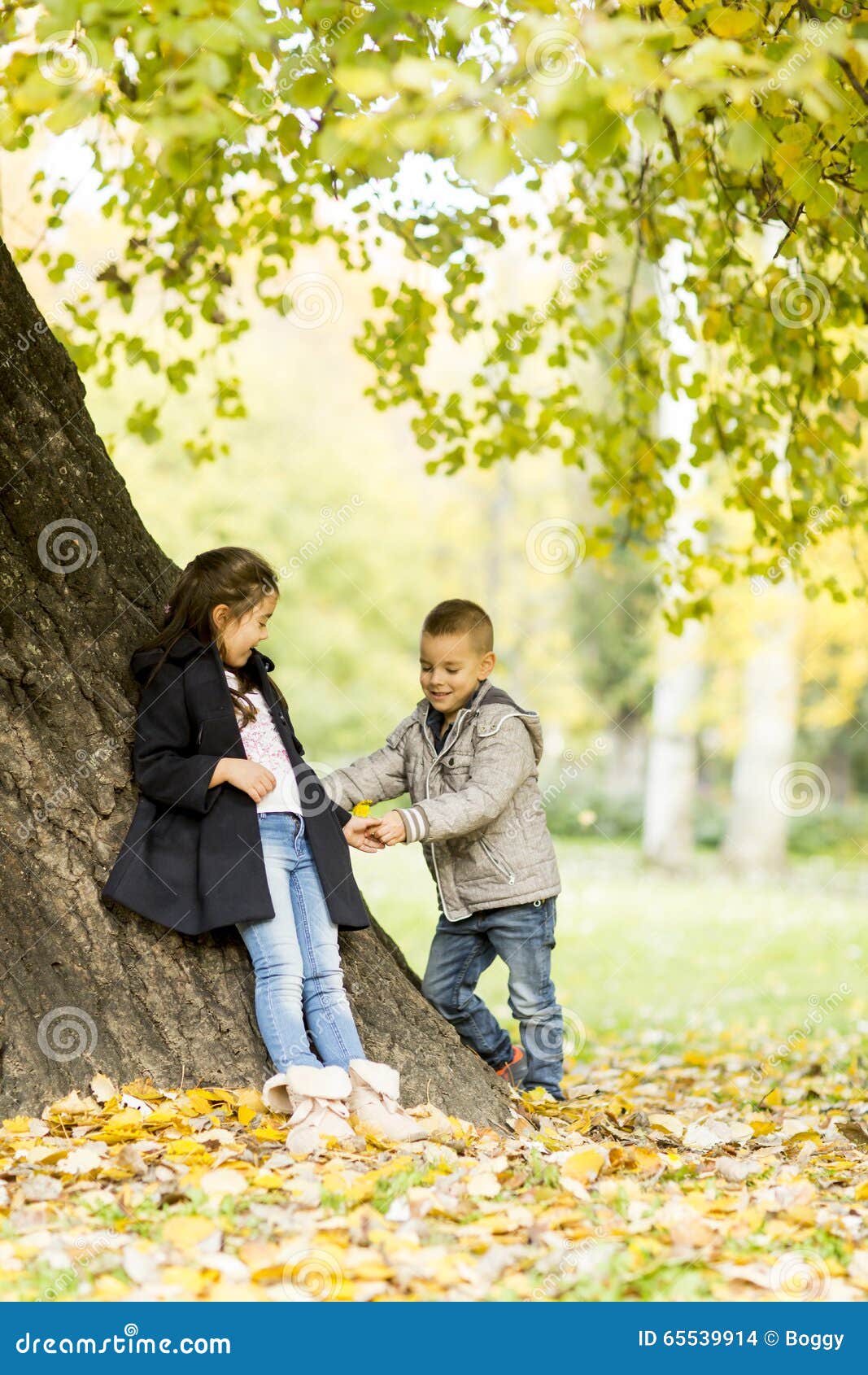 Kids in autumn park stock photo. Image of outside, yellow - 65539914
