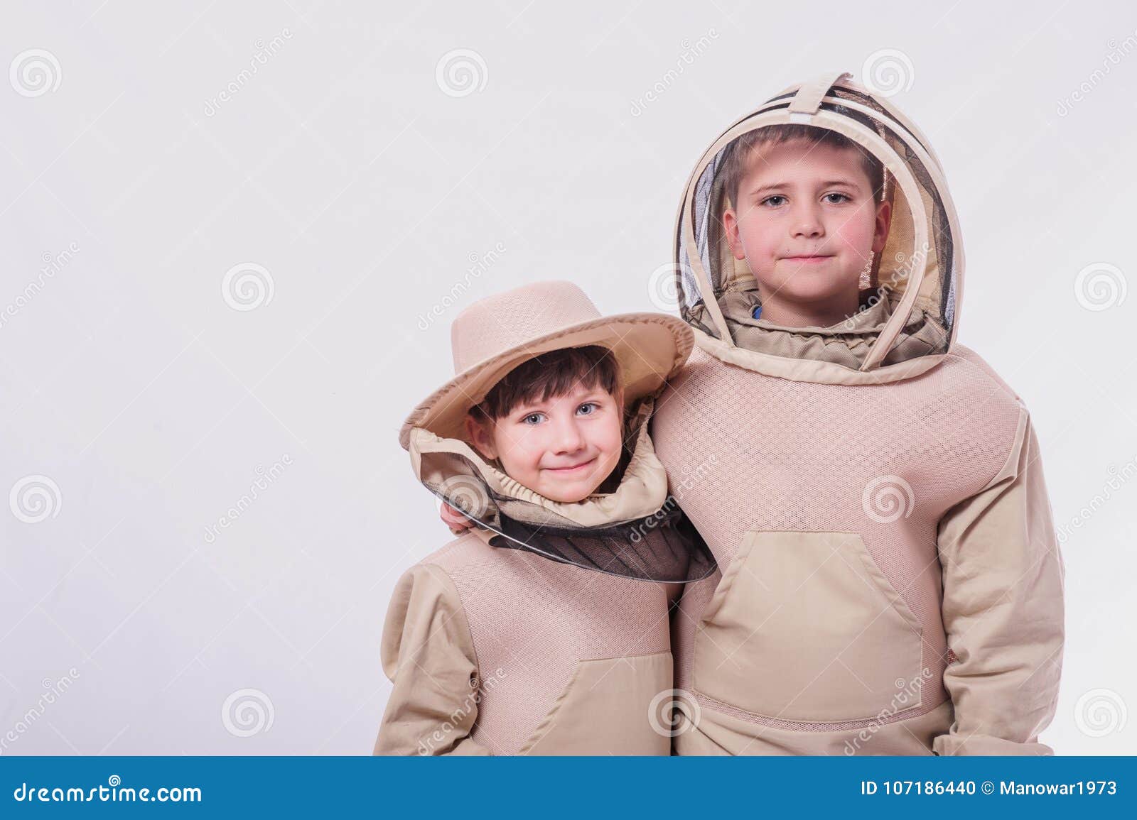 Kids in Beekeeper`s Suits Posing in Studio White Background. Stock ...
