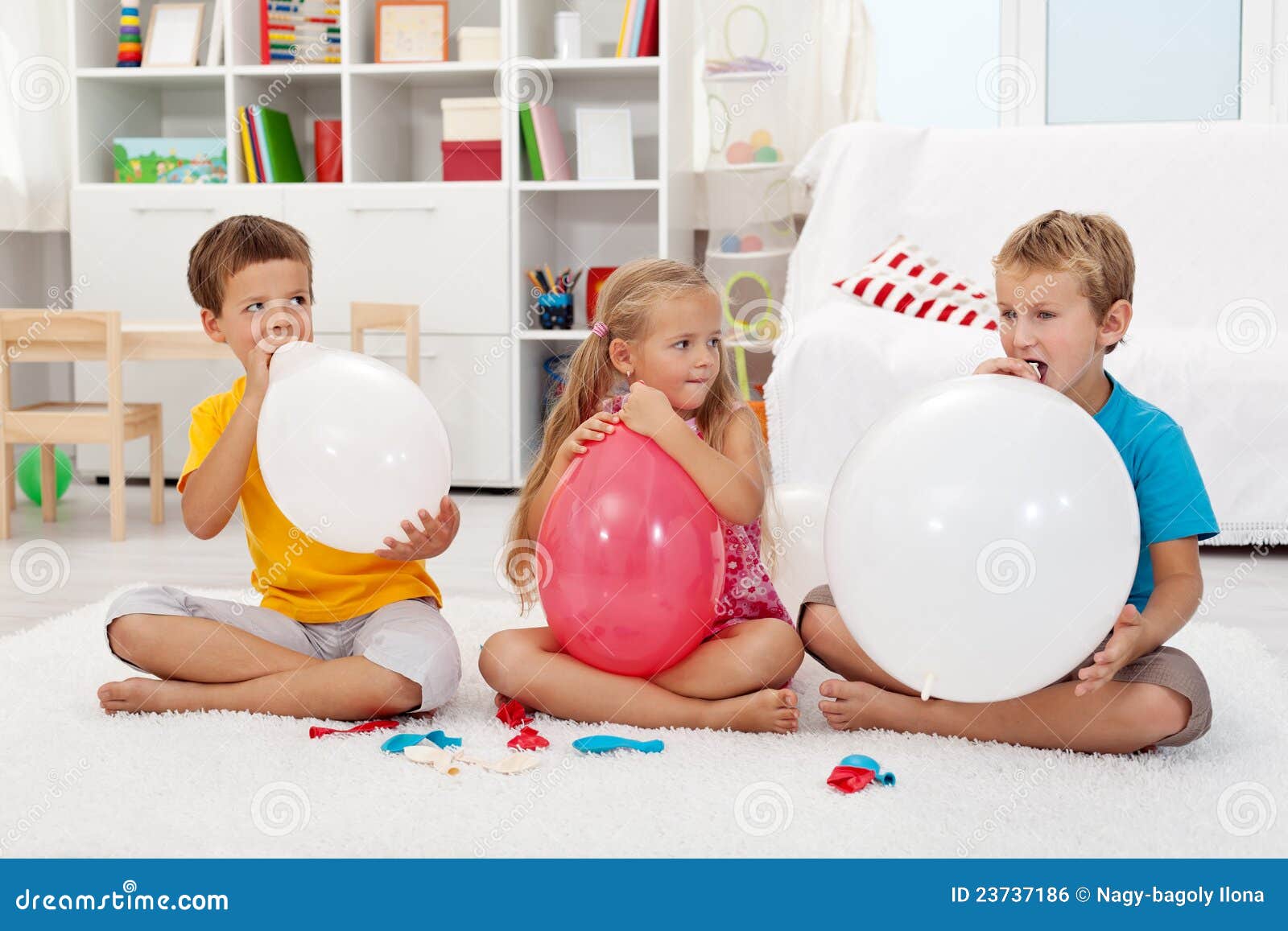 Kids blowing up balloons stock photo. Image of playing - 23737186