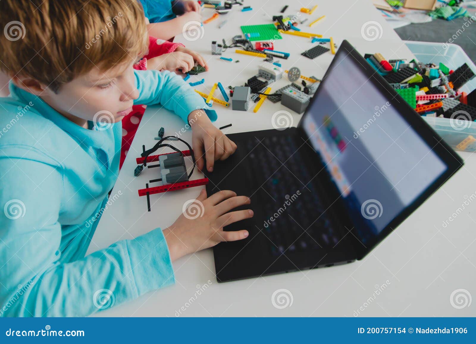 Kids Building Robot and Programming it on Computer Stock Photo - Image ...