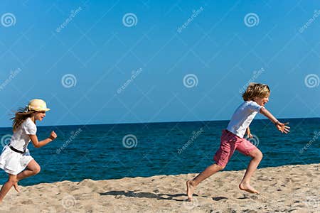 Kids chasing each other. stock image. Image of beach - 31229373