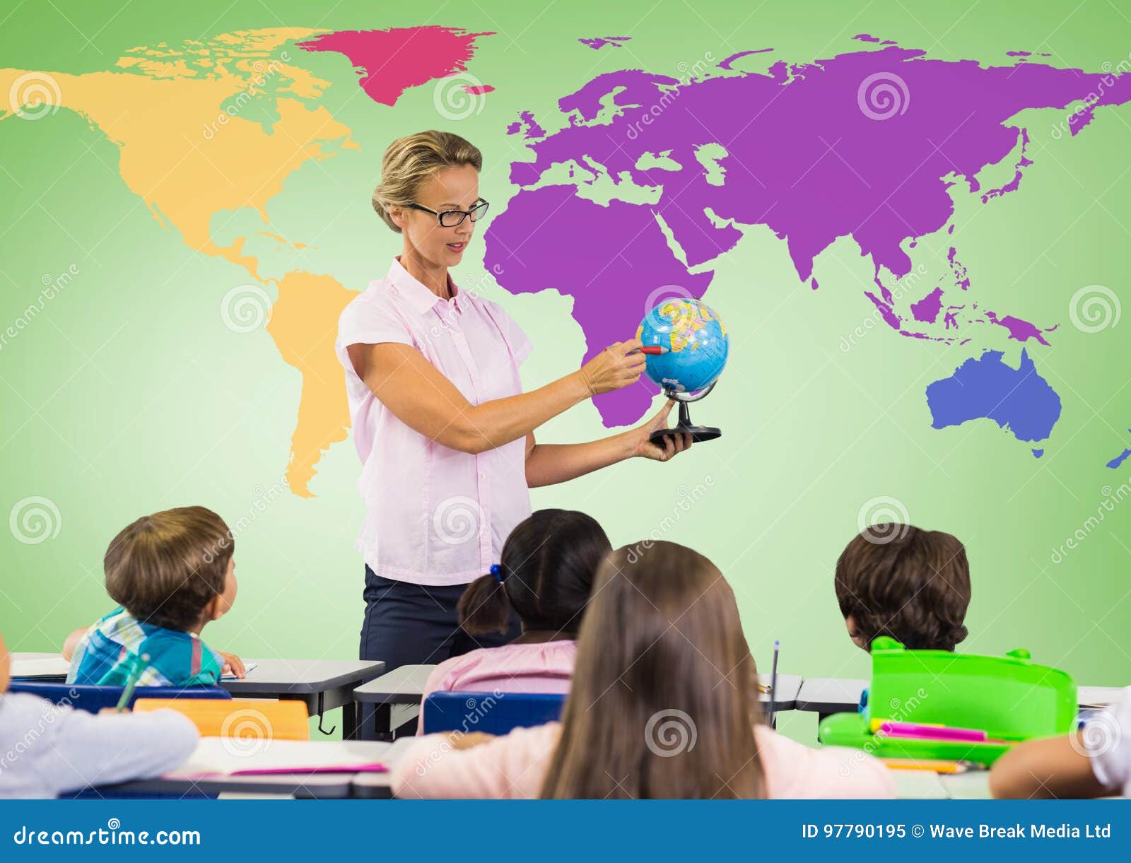 Kids in Class with Teacher Holding Globe in Front of Colorful World Map ...