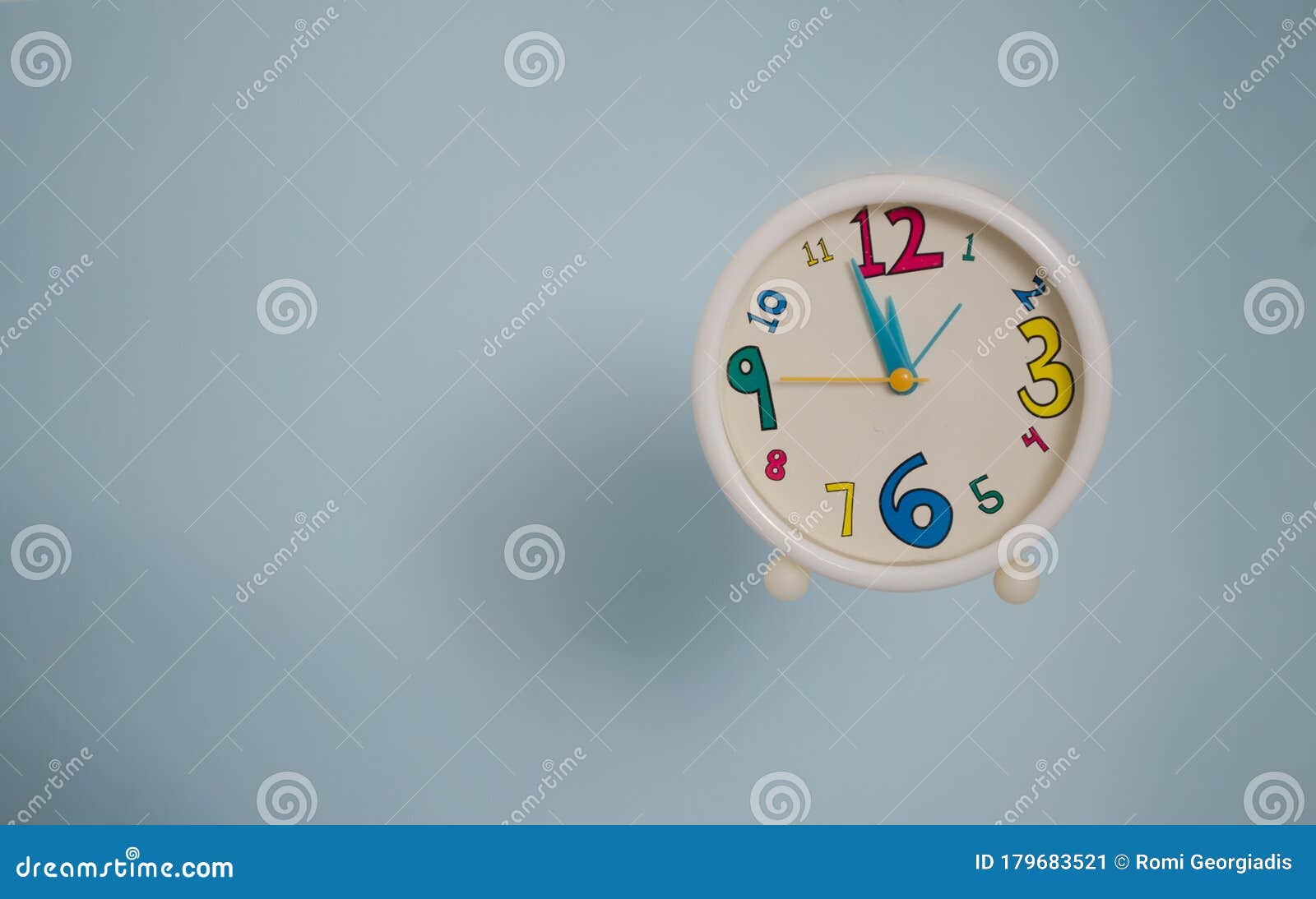 Kids Clock Floating in Light Blue Background with Copy Space Stock ...